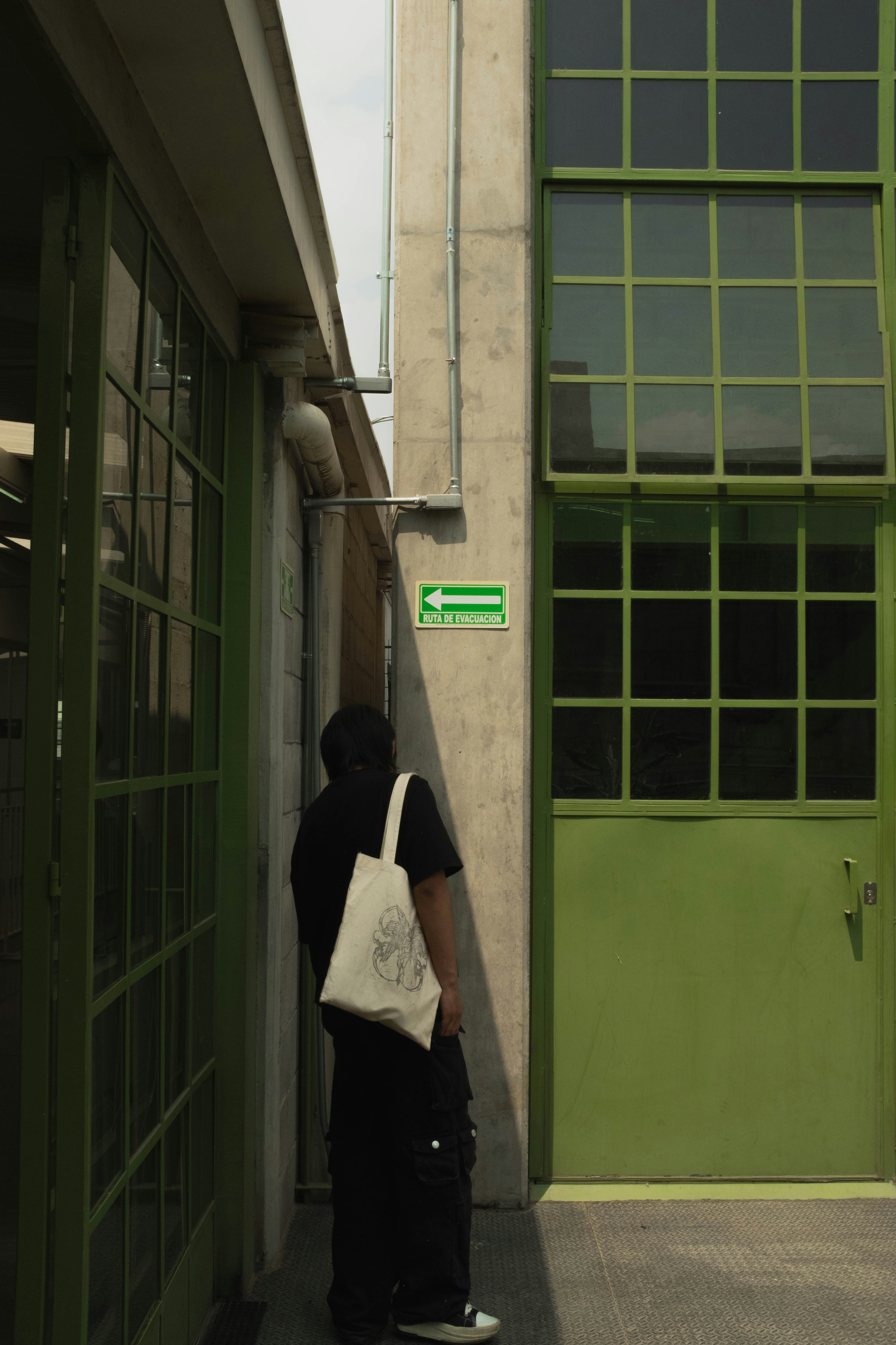 Lone Figure in a Lime-Framed Urban Corridor