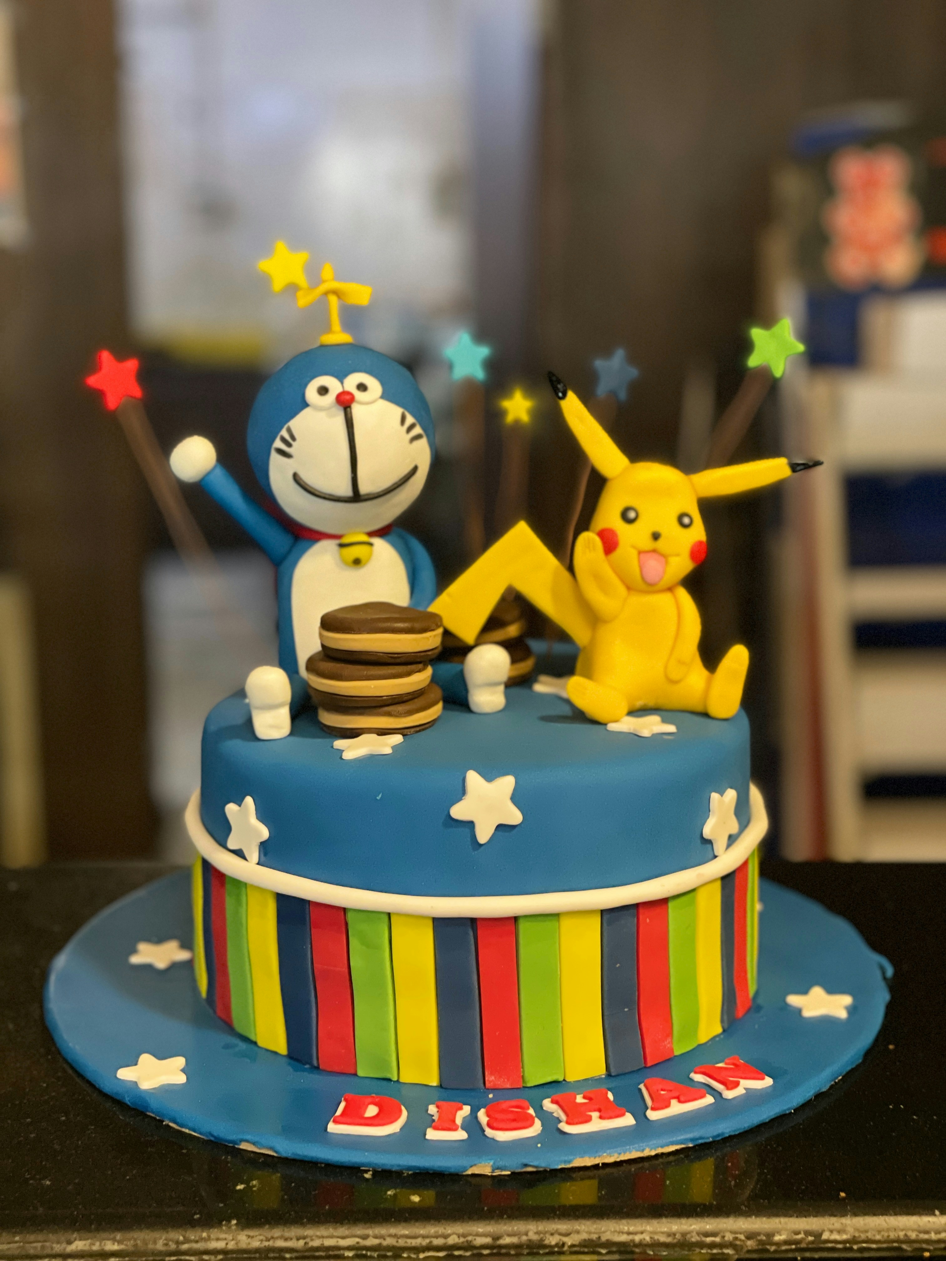 Doraemon and Pikachu Guard a Rainbow-Striped Birthday Cake