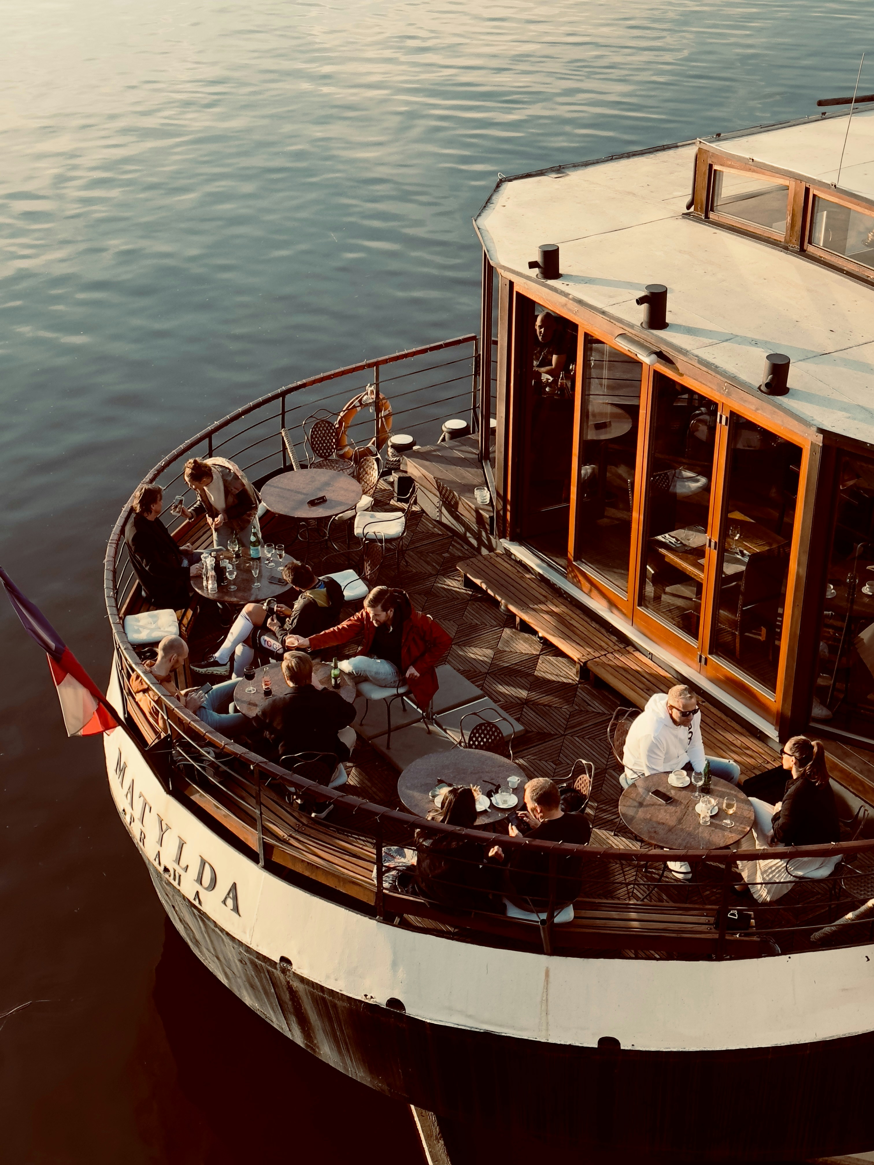Evening Circle Afloat: Diners on a Circular Riverboat Deck