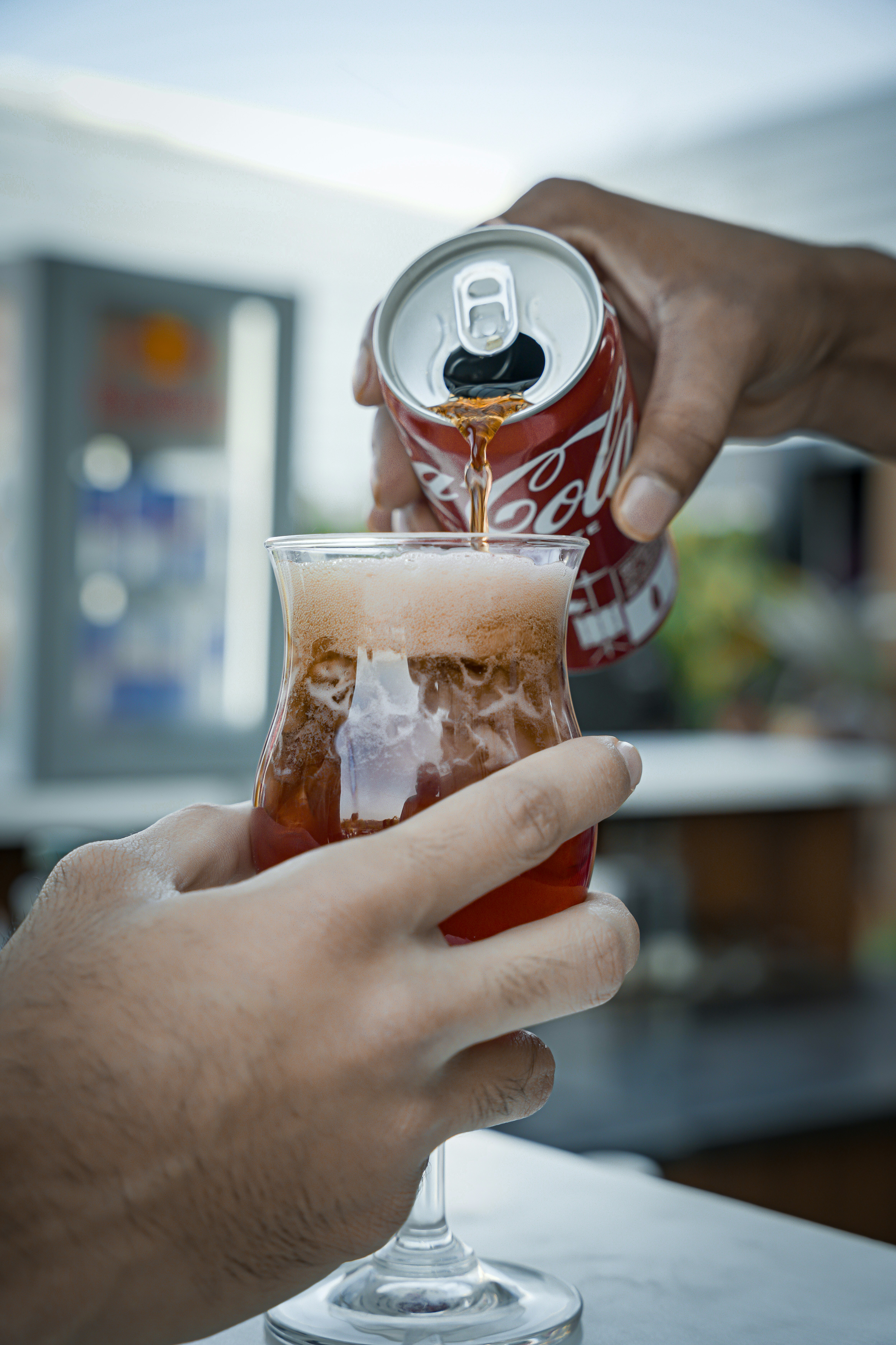Pouring Cola Magic: A Foam Crown Over Glassy Glasses