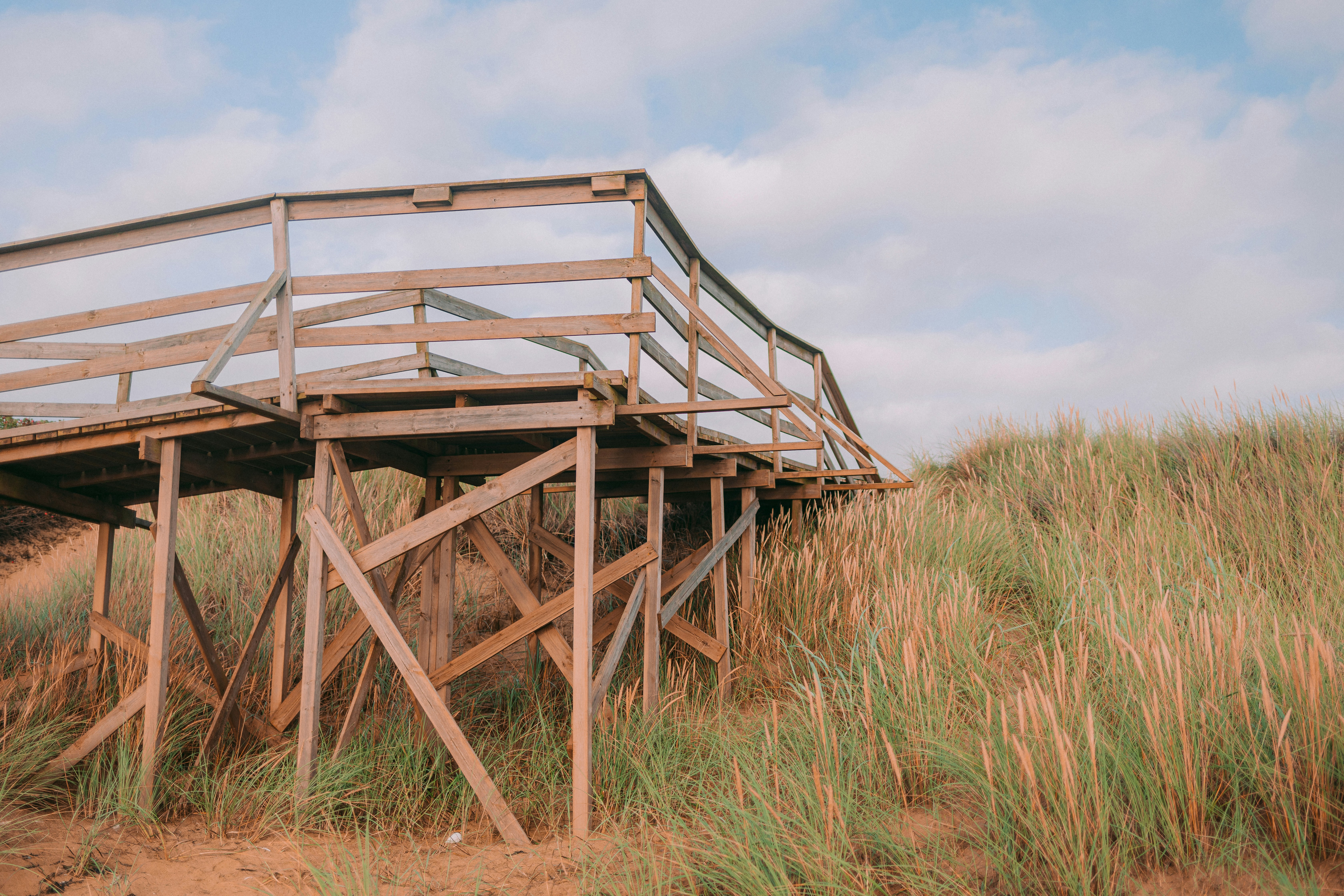 Dune Edge: Weathered Boardwalk Reaching Toward a Blue Sky