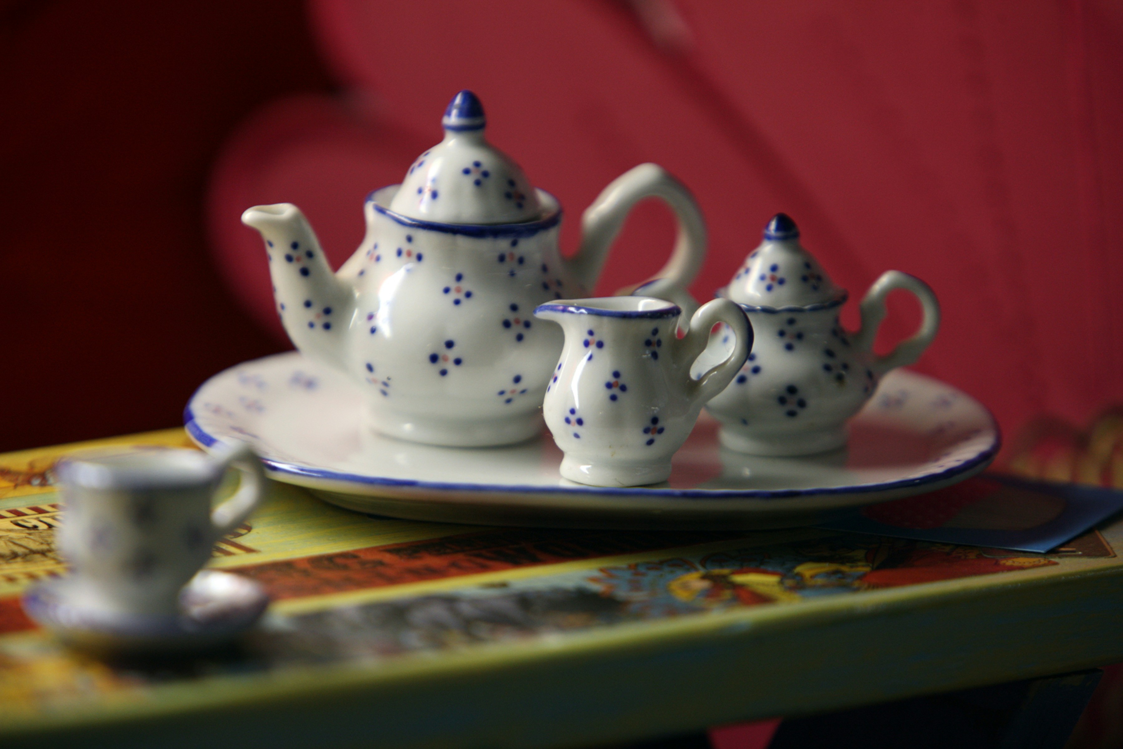 Blue-Dotted Teaset on a Colorful Tray in Soft Focus