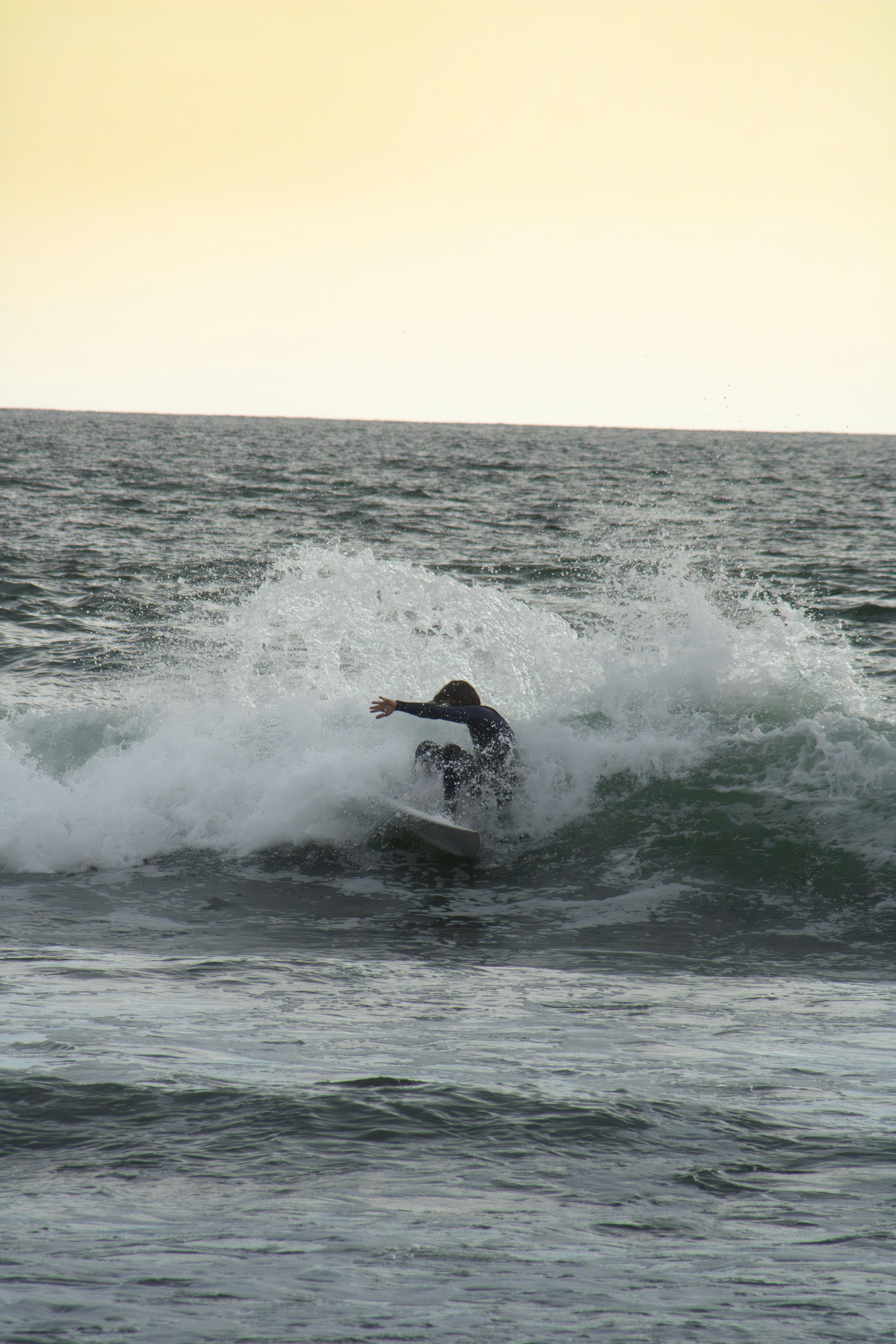 A person riding a surfboard on a wave in the ocean photo – Free Woman ...