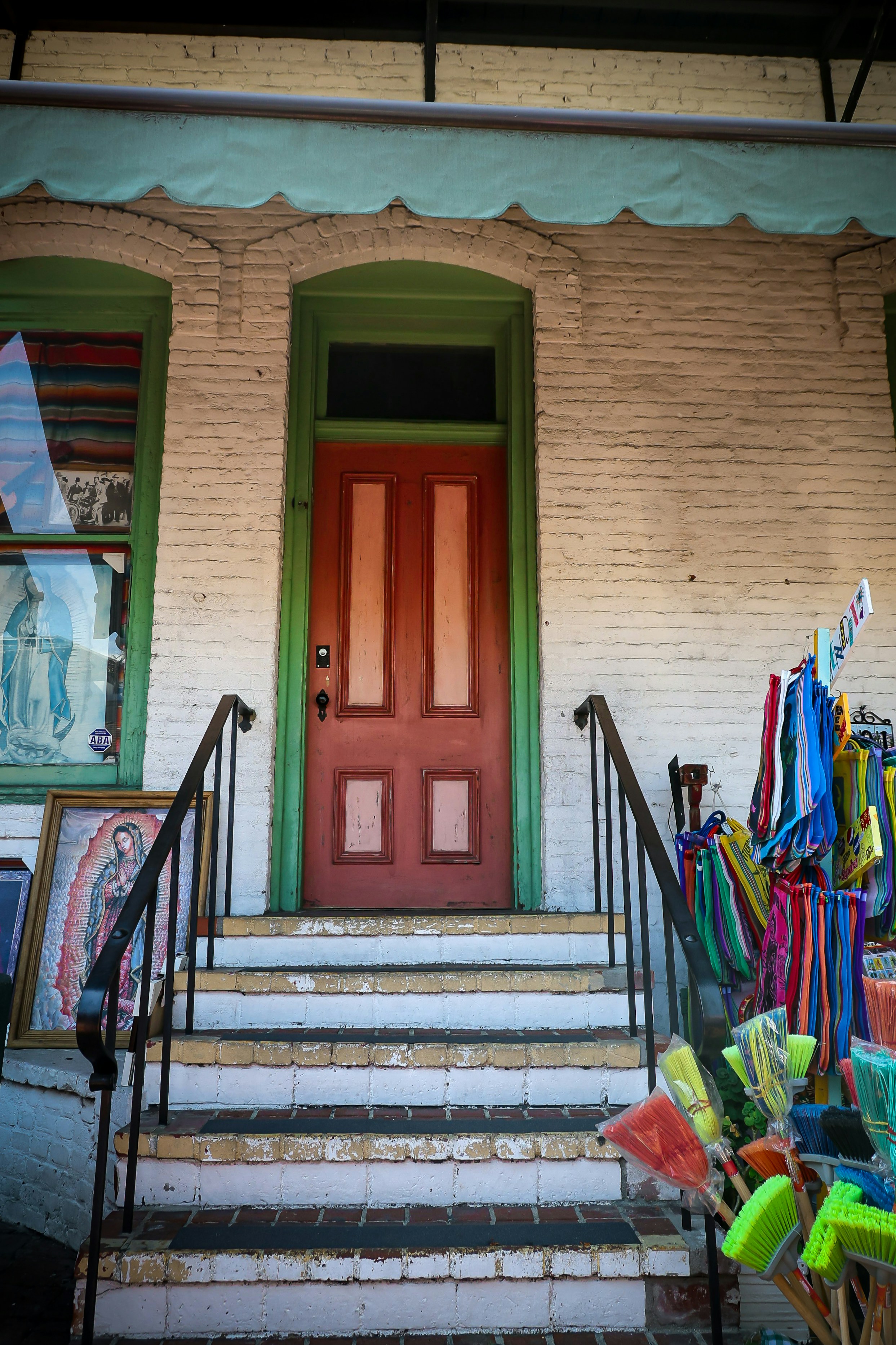 Red Door on a Sunlit Porch: A Colorful Secret Shopfront