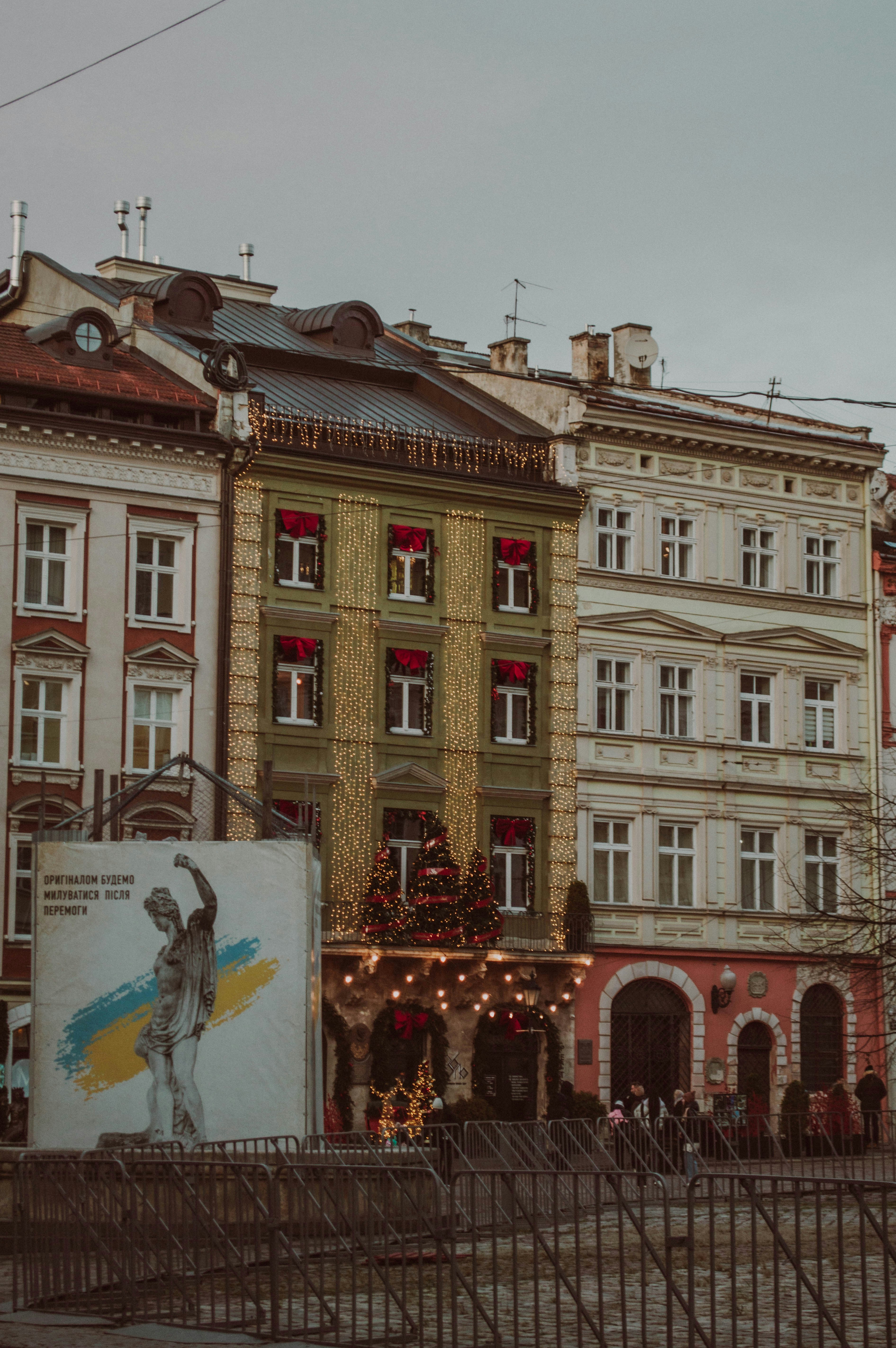 Green Facade Alight: Christmas Glow on a Historic Street