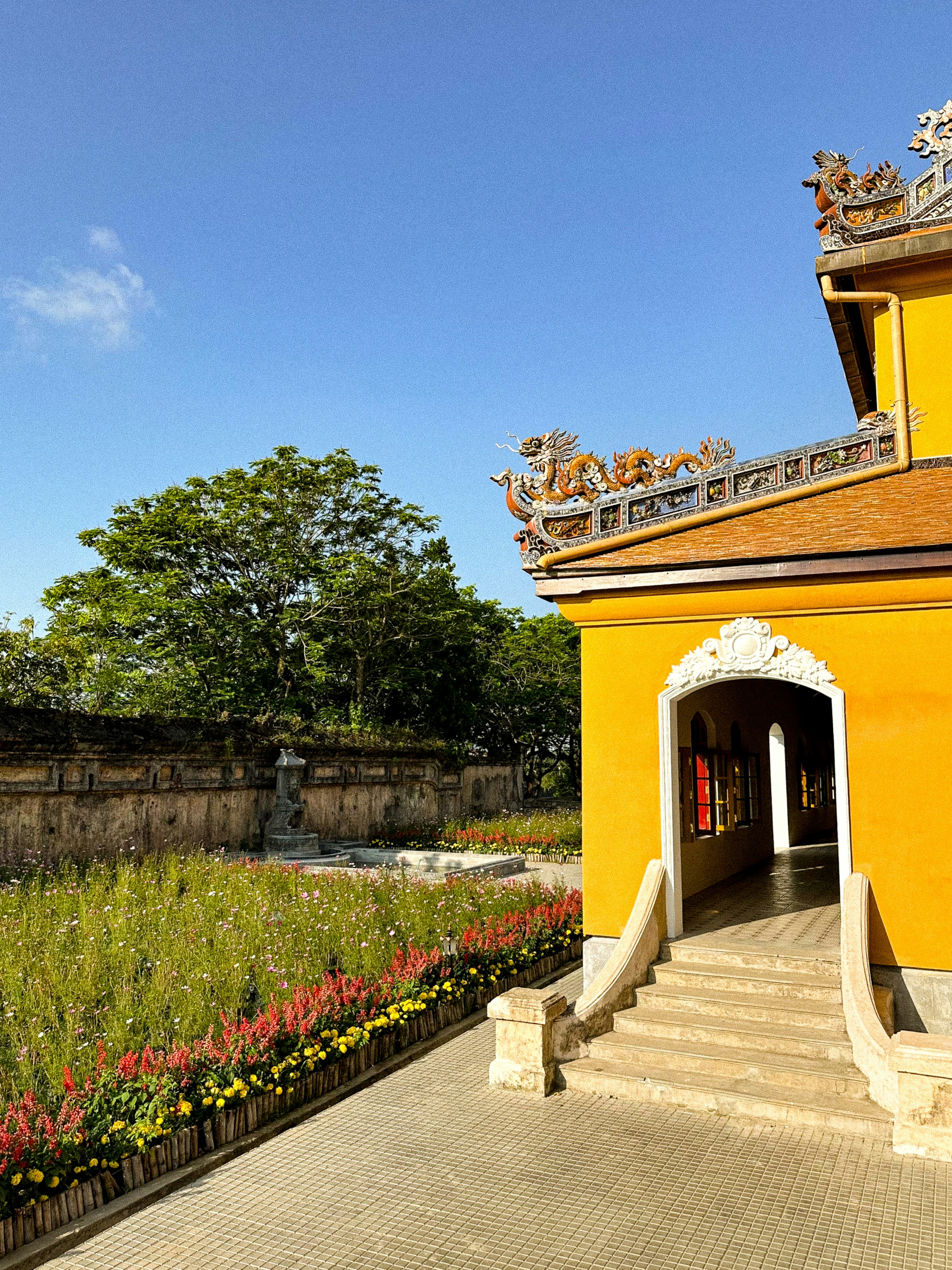 Sunlit Threshold: Dragon-Roofed Yellow Temple at Noon