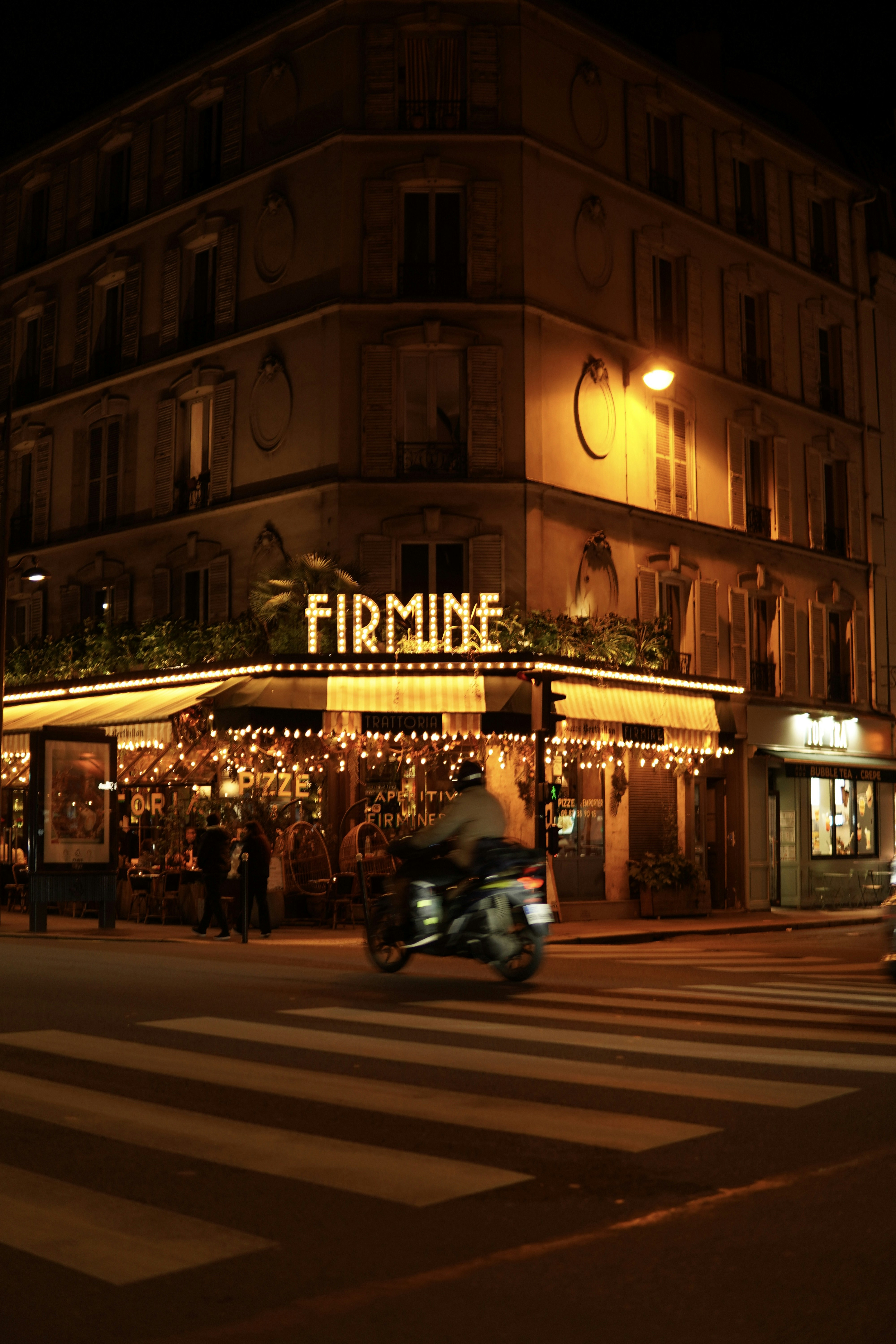 Corner Café Glow: Neon Lanterns, Motion Blur, and Nightlife on a Parisian Street