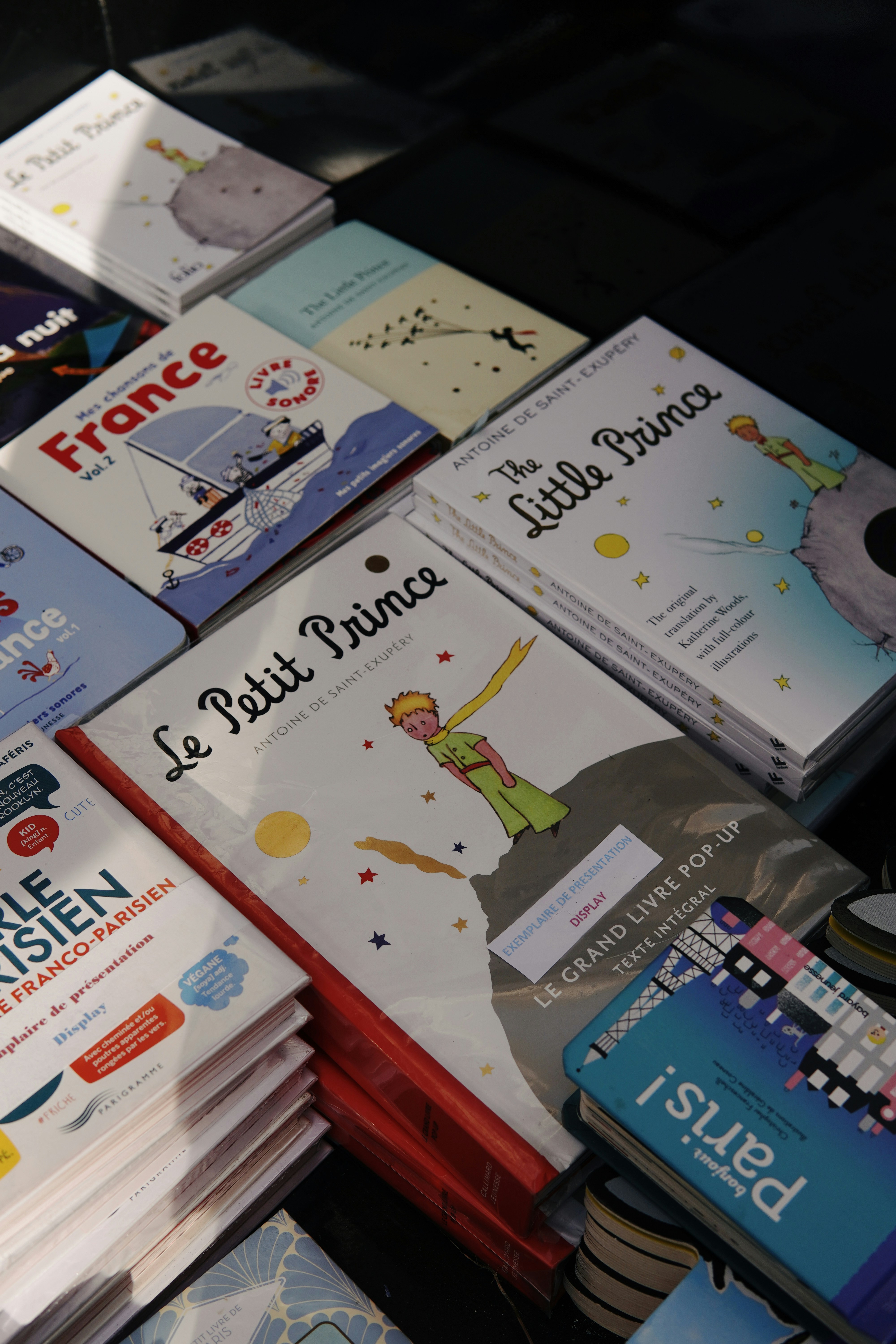 A pile of children's books sitting on top of a table photo – Free Paris ...