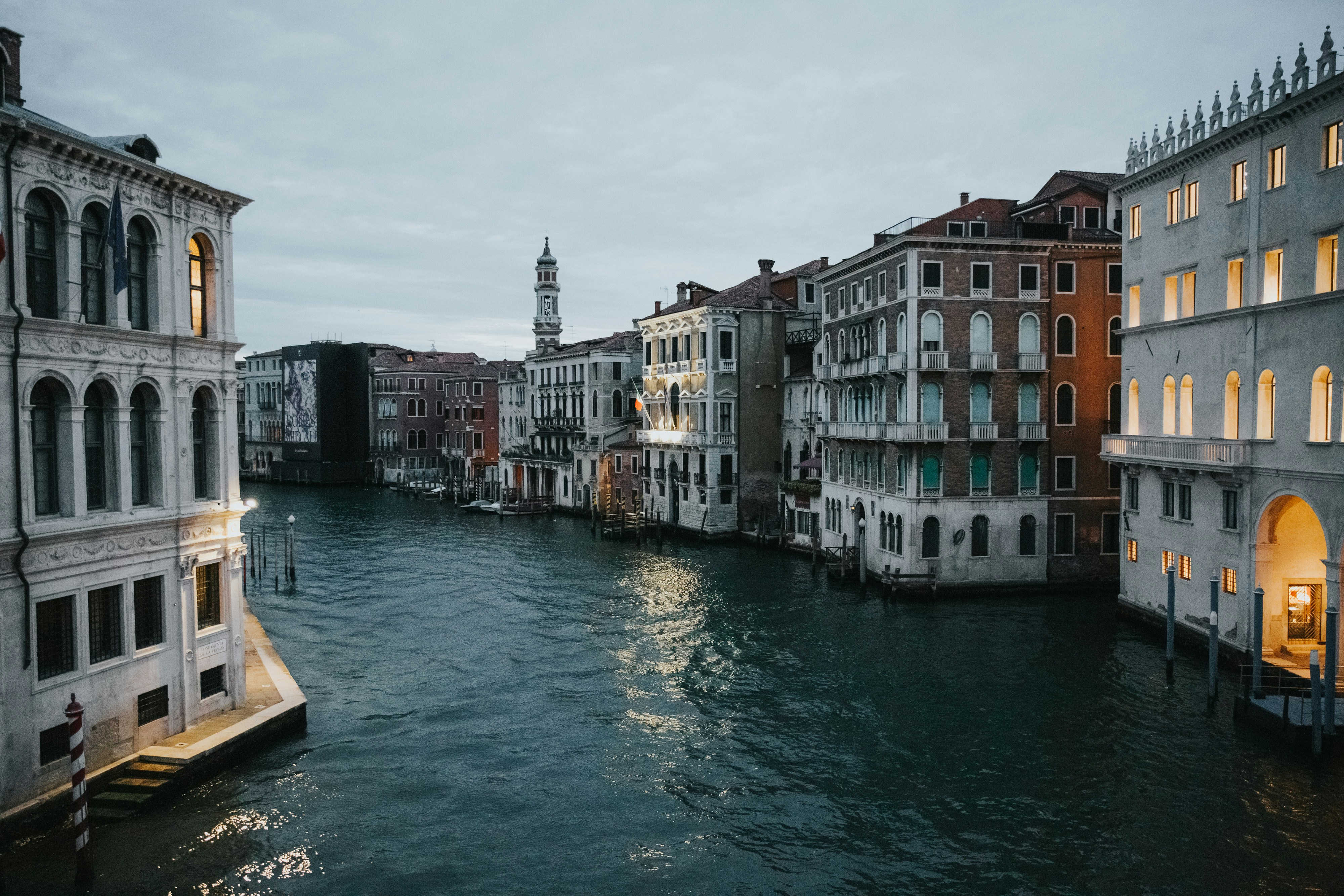 A river running through a city next to tall buildings photo – Free ...