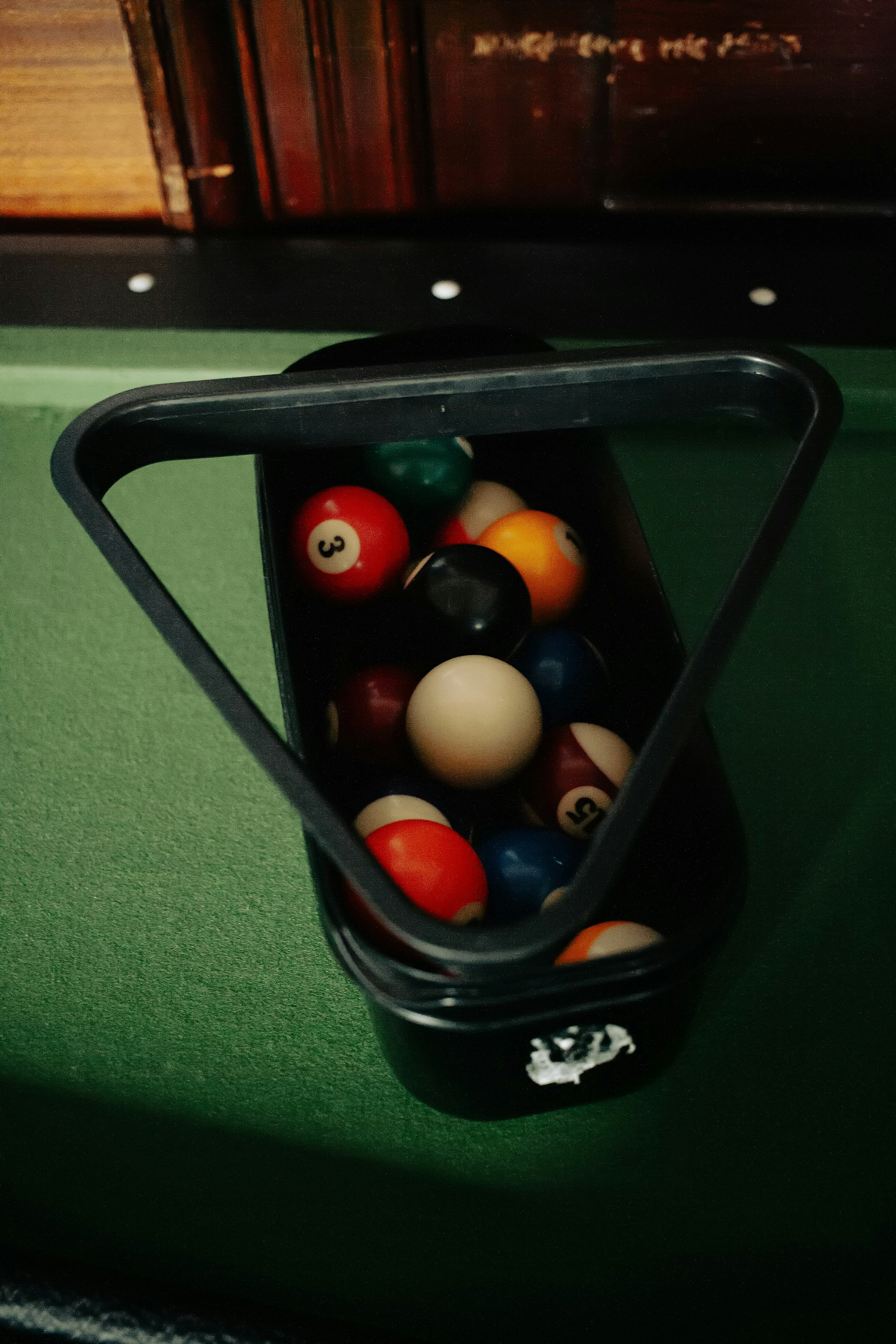 a pool table with a rack of pool balls