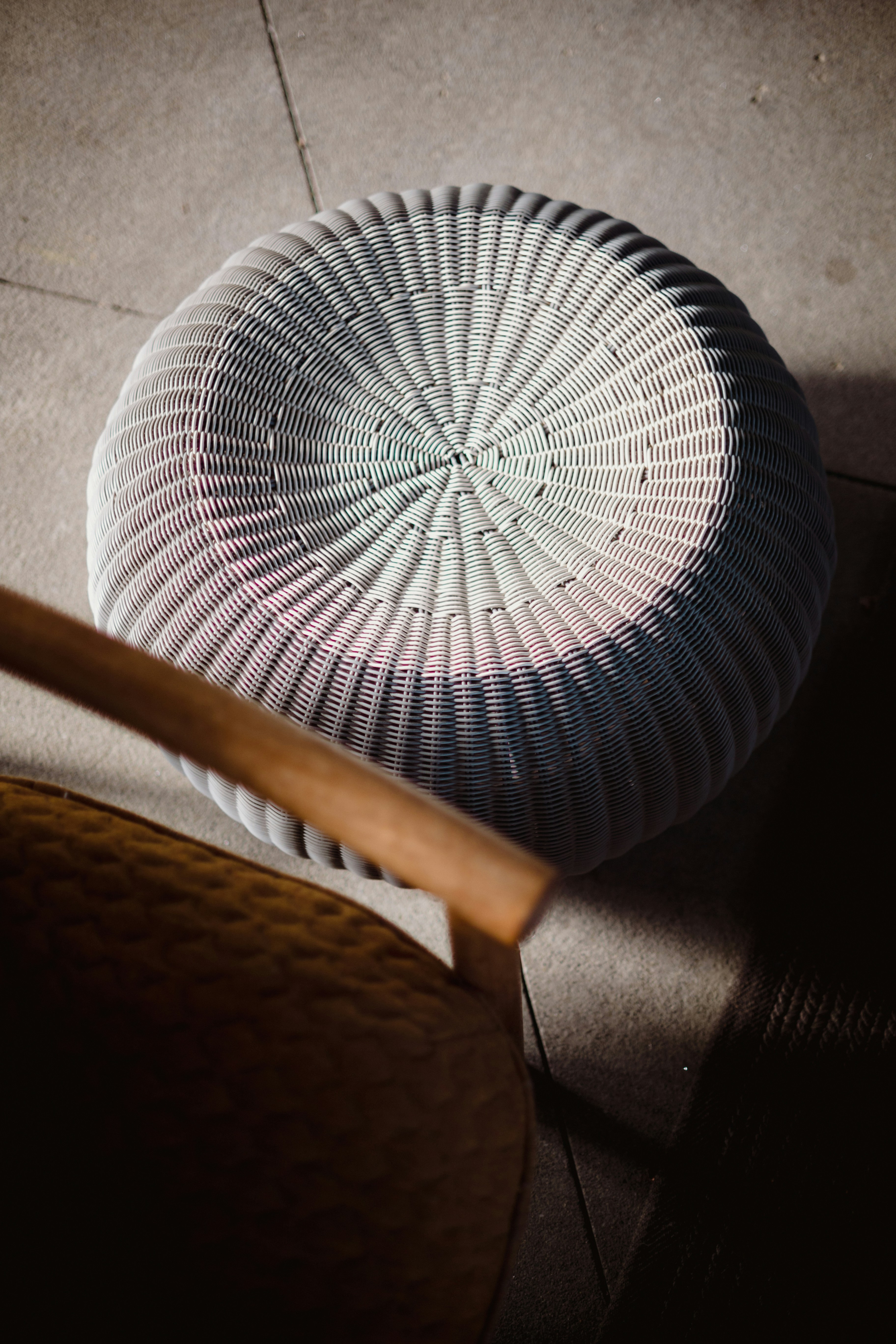 Circular Weave: A Cushioned Stool Beckons in Subtle Light