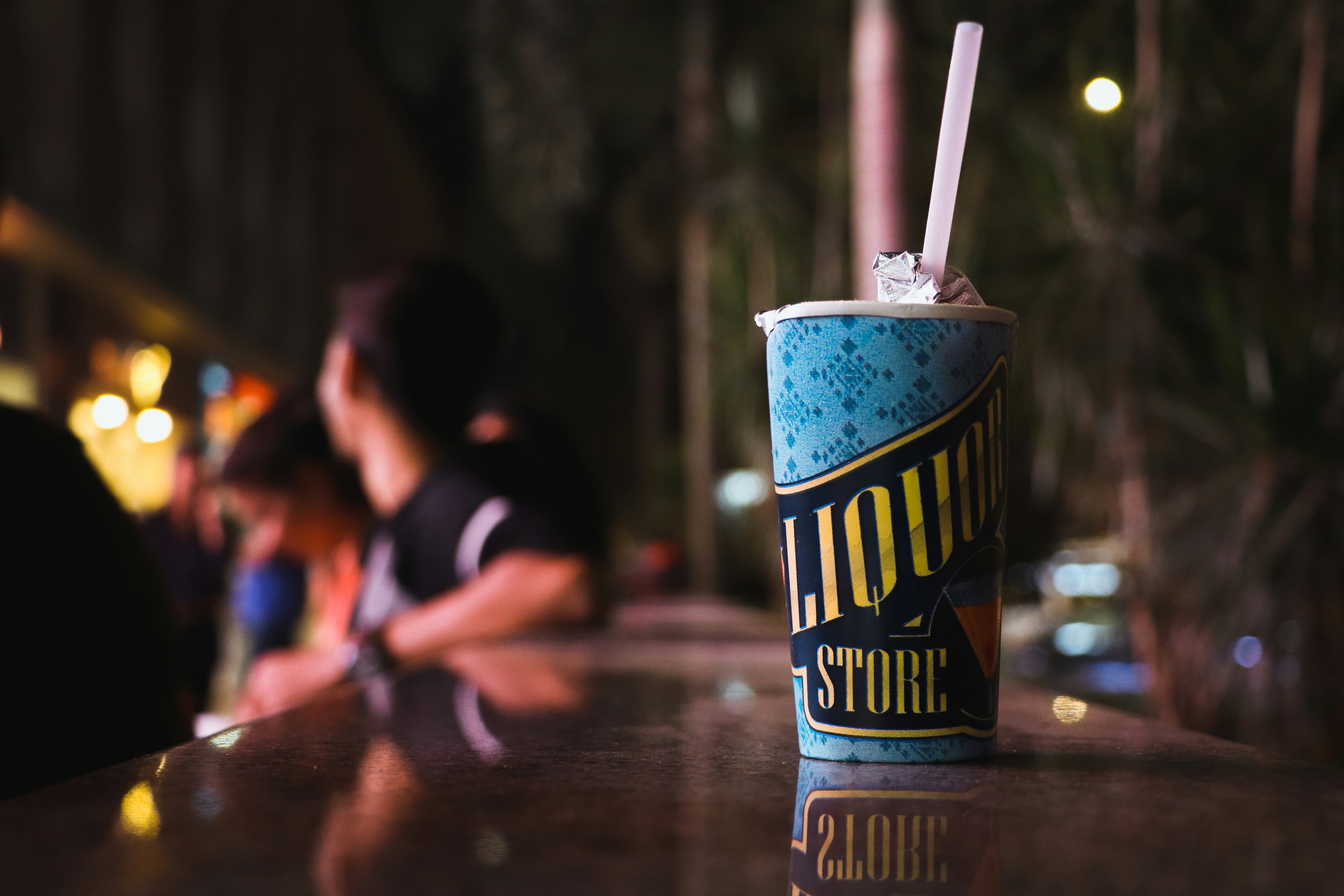 Blue Cup under Neon Glow: A Quiet Night at the Counter