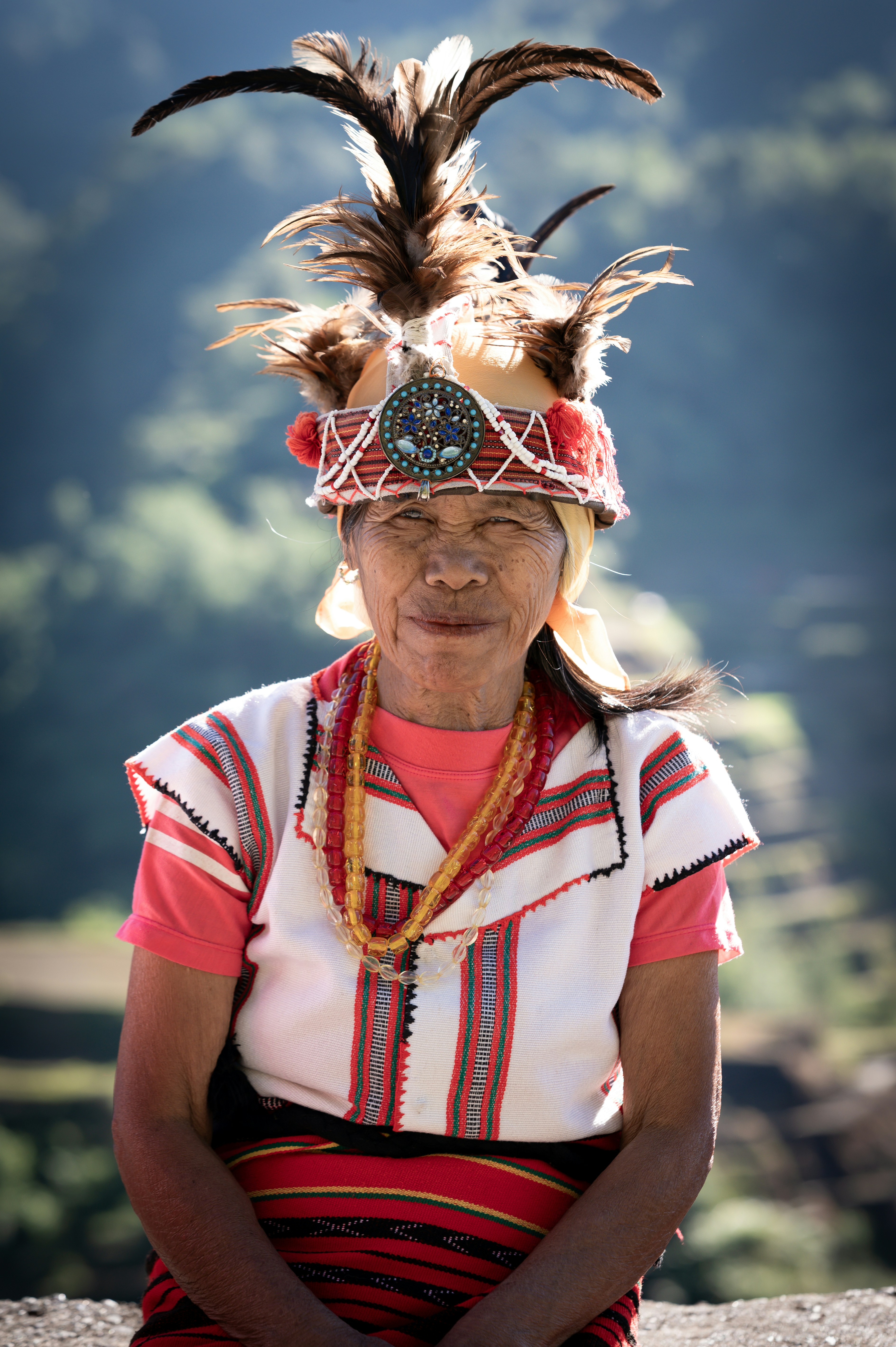A woman wearing a headdress sitting on a rock photo – Free Banaue rice ...