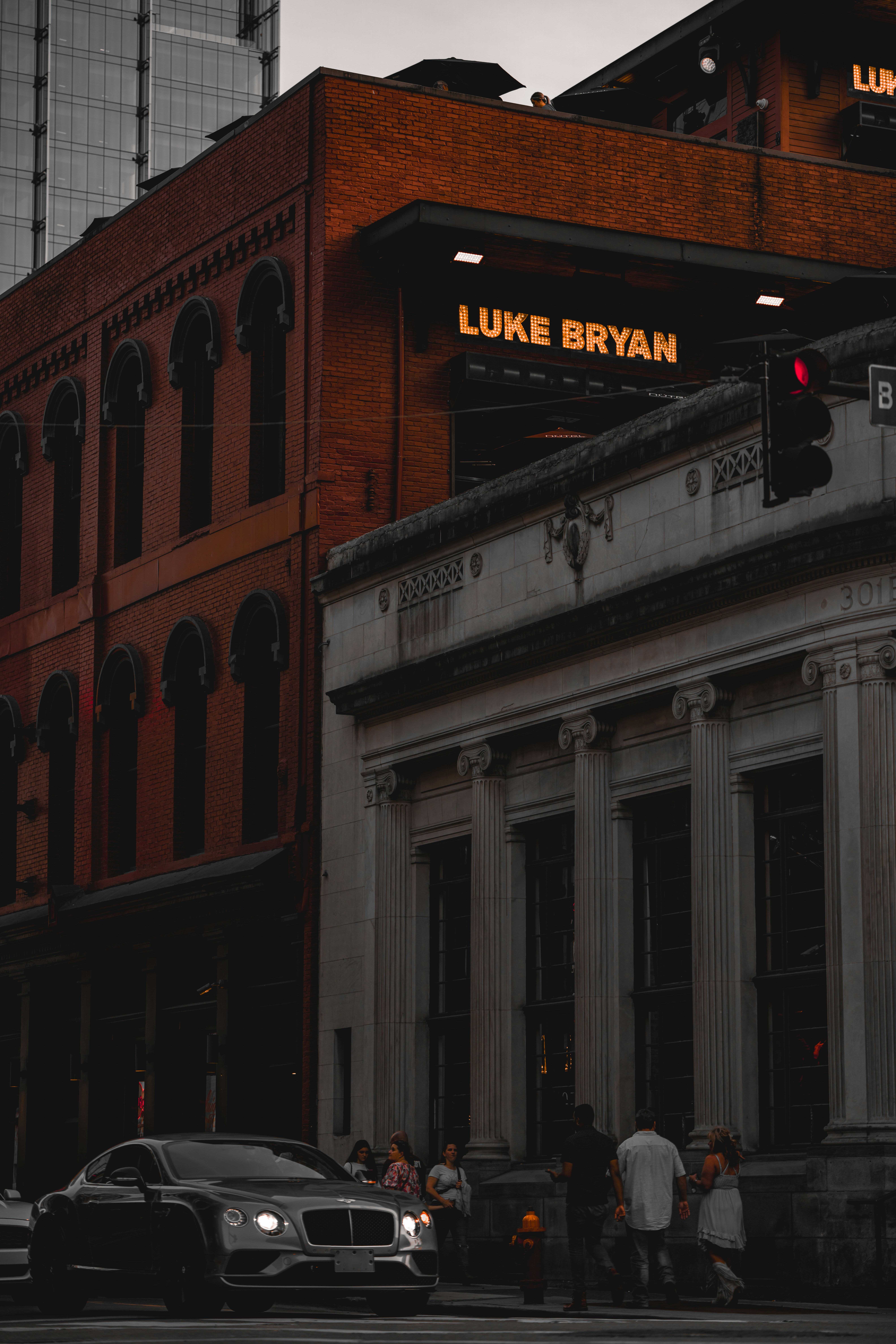 A group of people standing outside of a building photo – Free Car Image ...