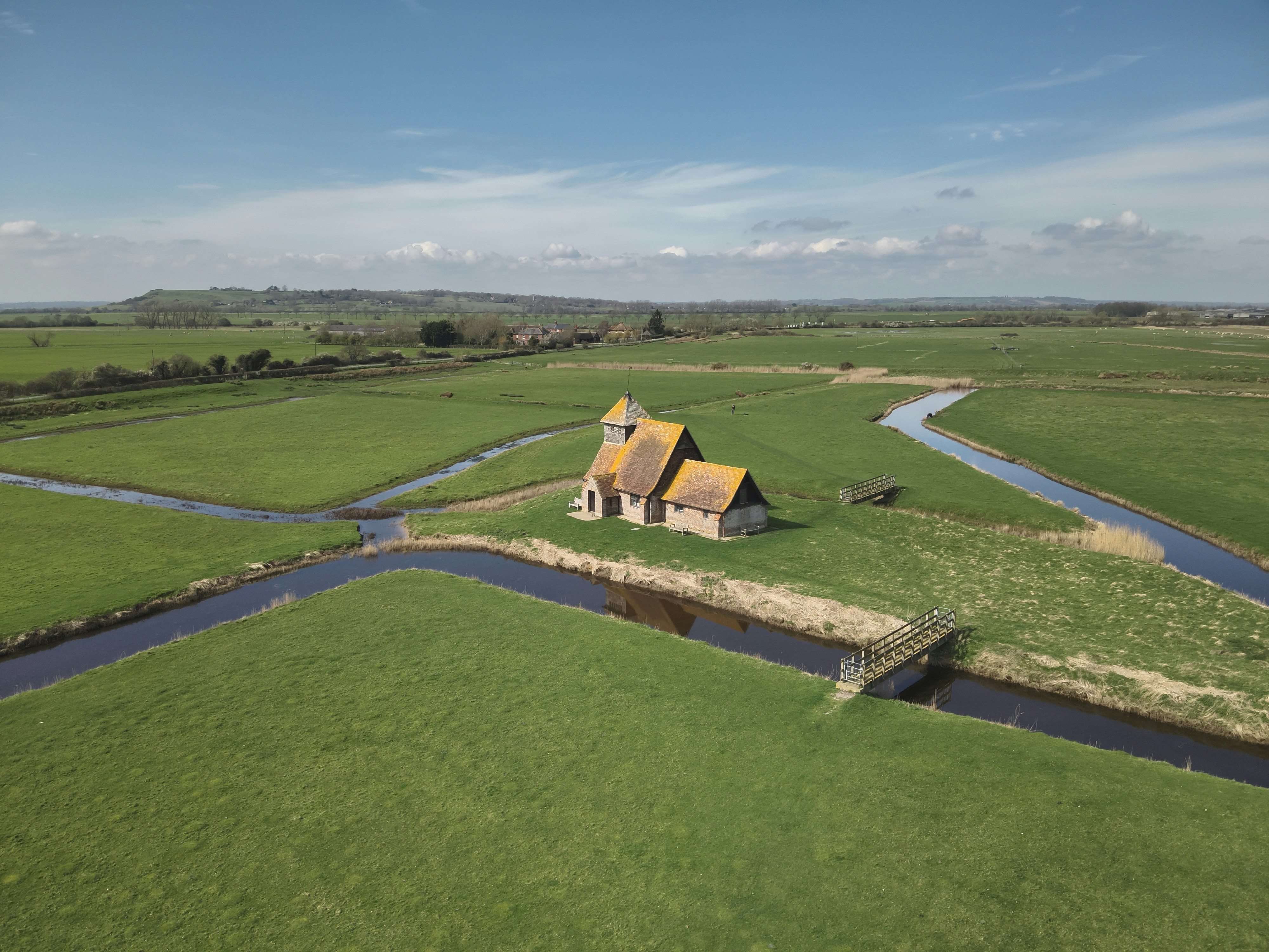 A solitary chapel amid a braided river of green fields