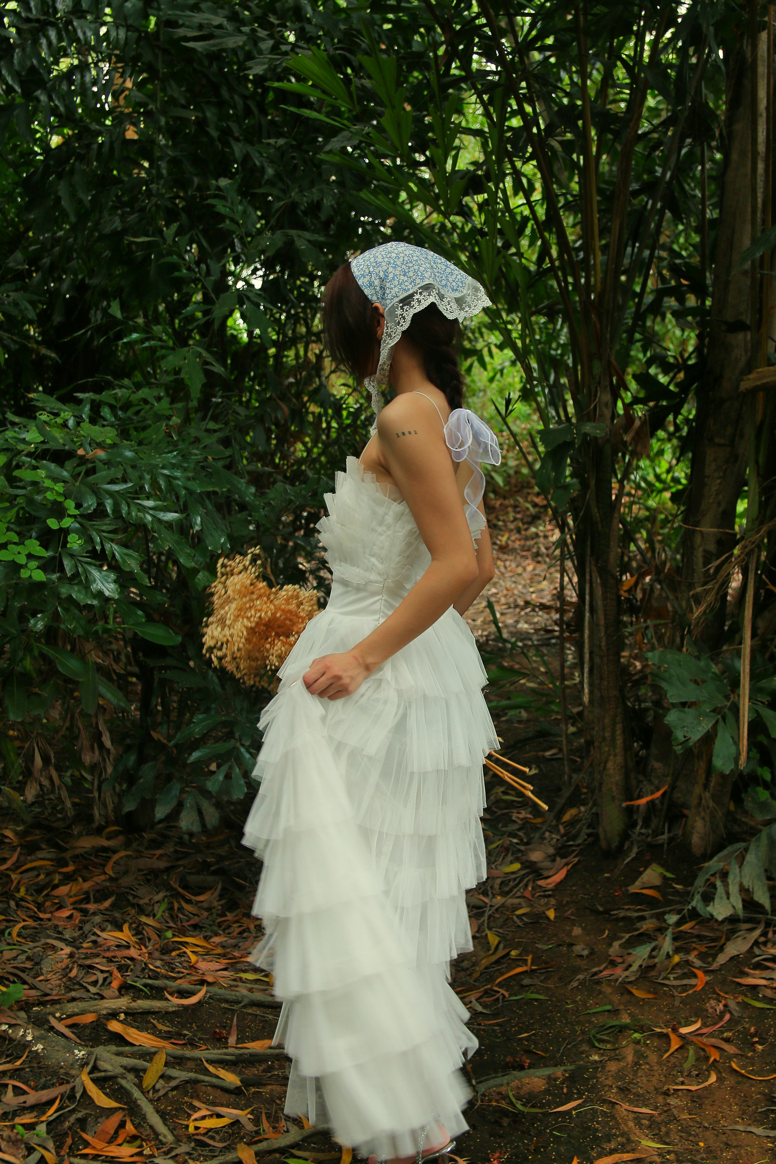 Tiered White Gown in a Hidden Garden: Portrait of Quiet Grace