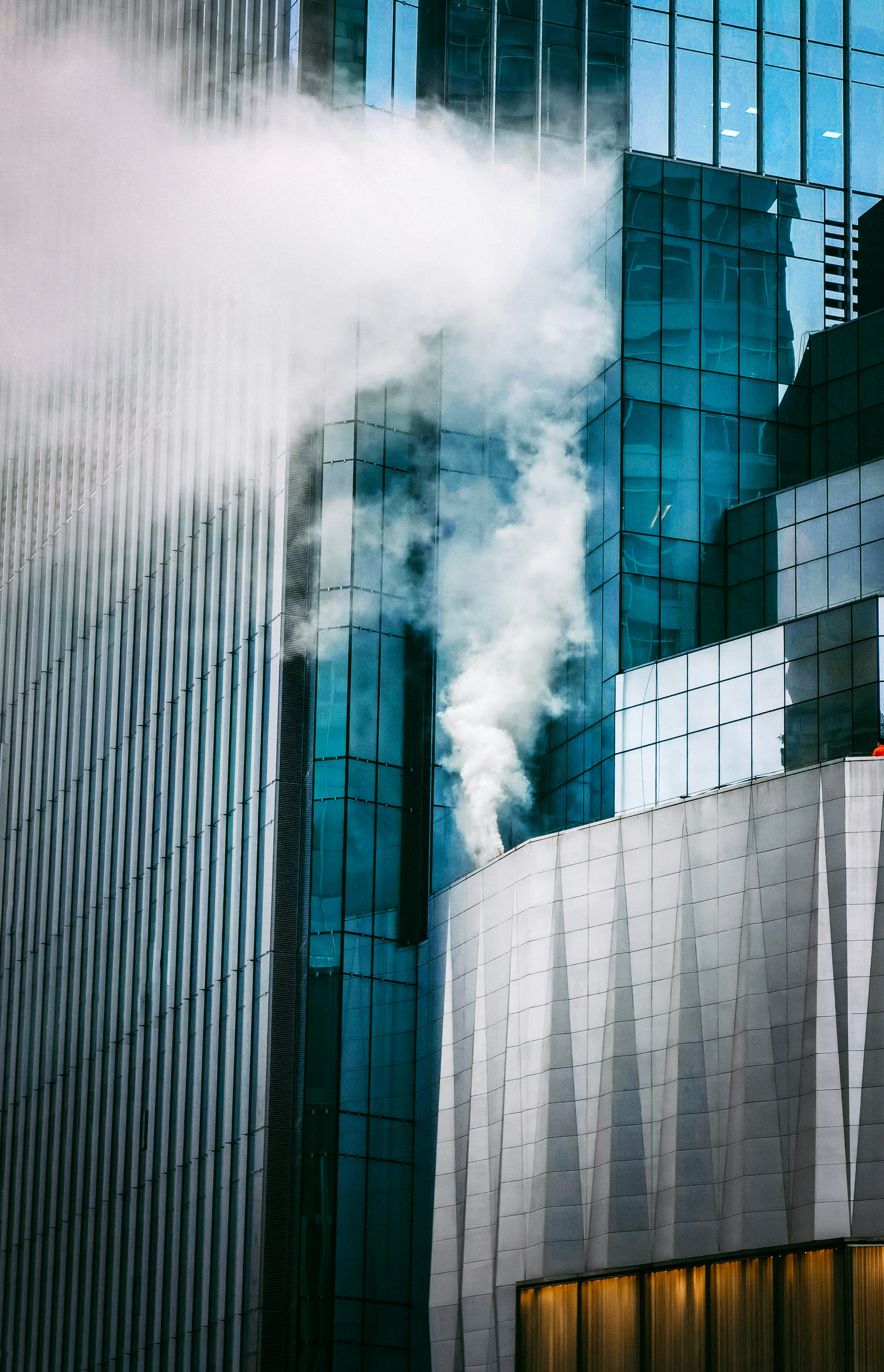 A building with smoke coming out of it photo – Free Building Image on ...