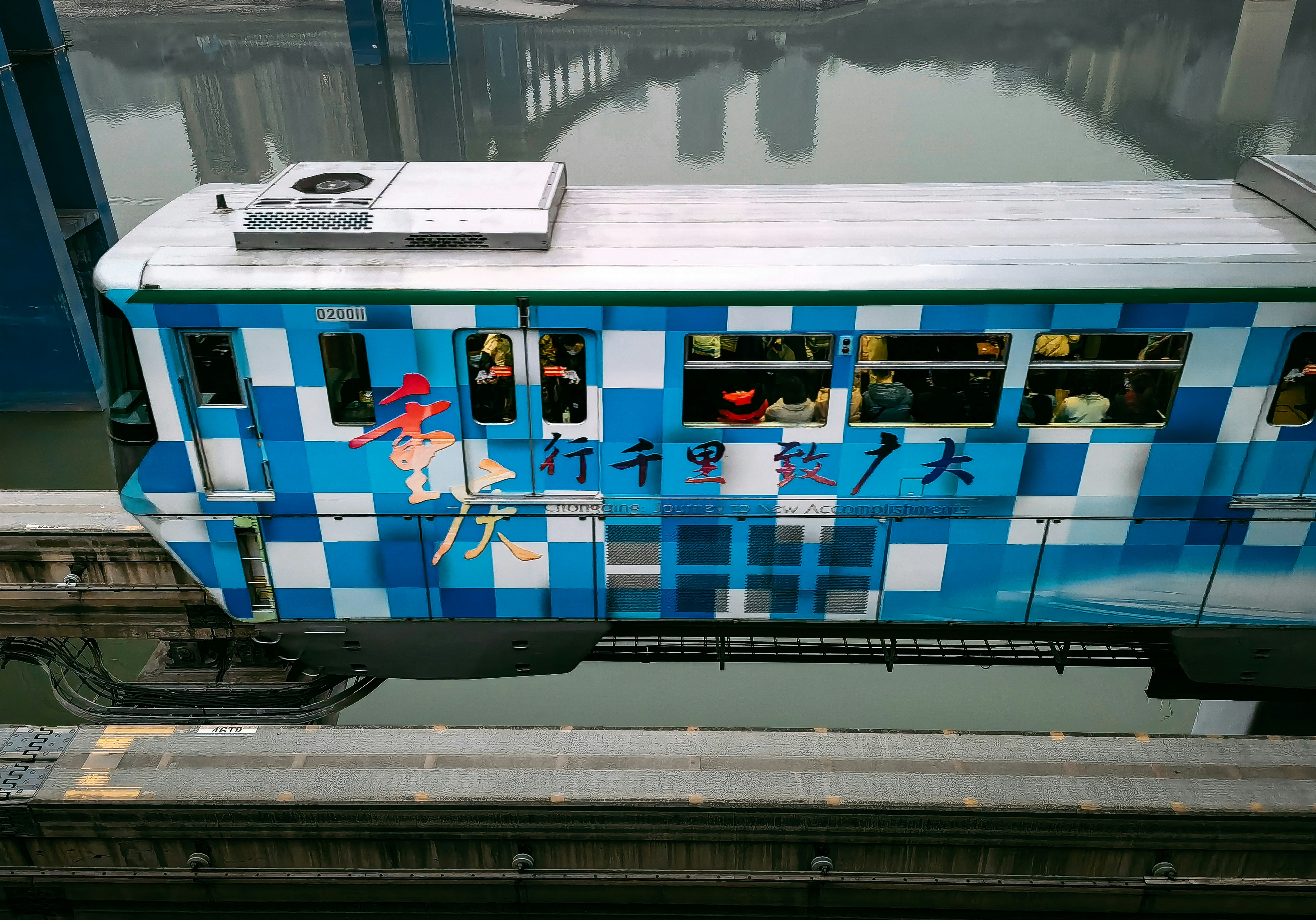 Checkerboard Blue Vessel Skims a Reflective Canal