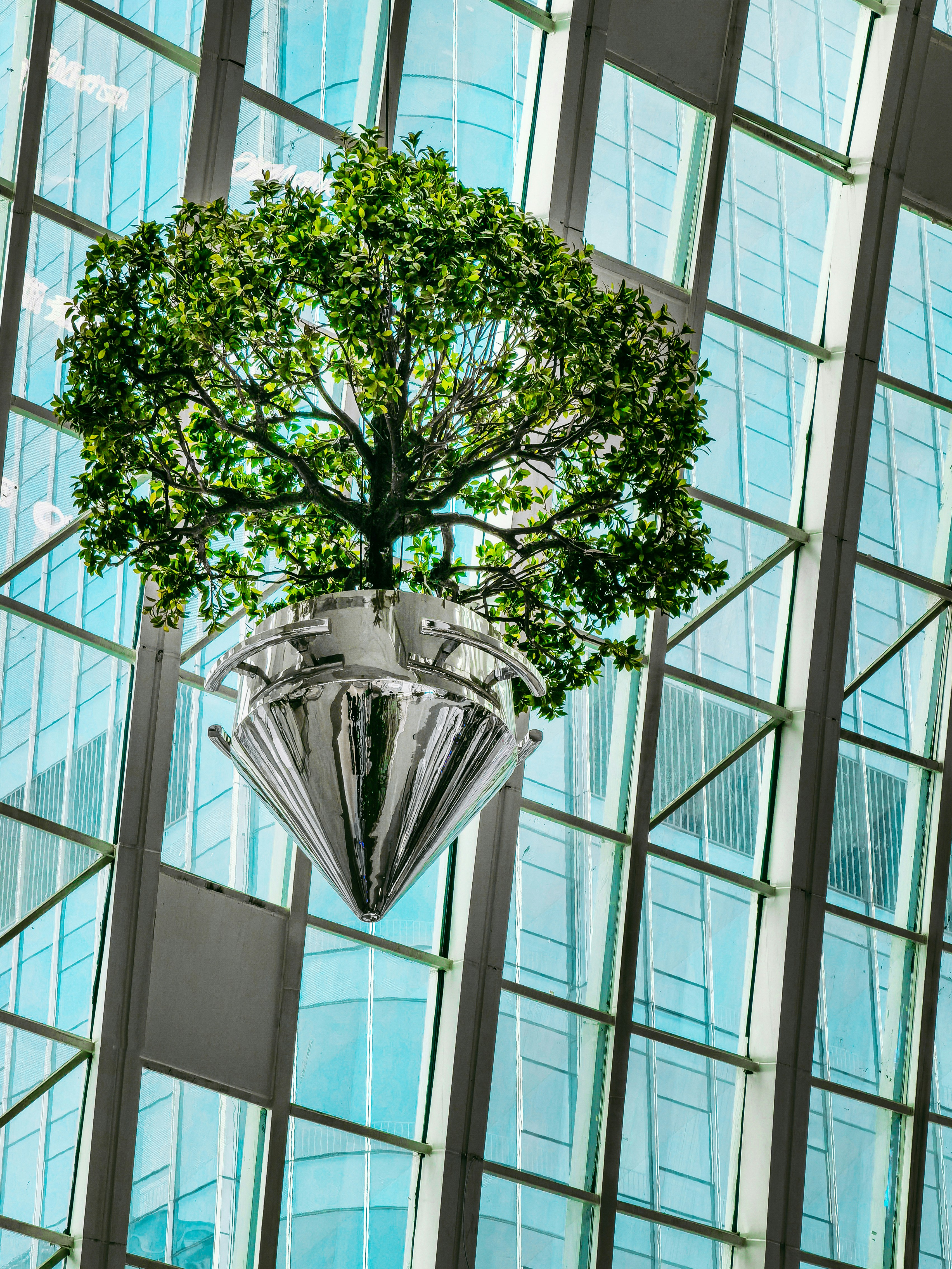 Upside-Down Urban canopy: A floating verdant sculpture above a metallic cone
