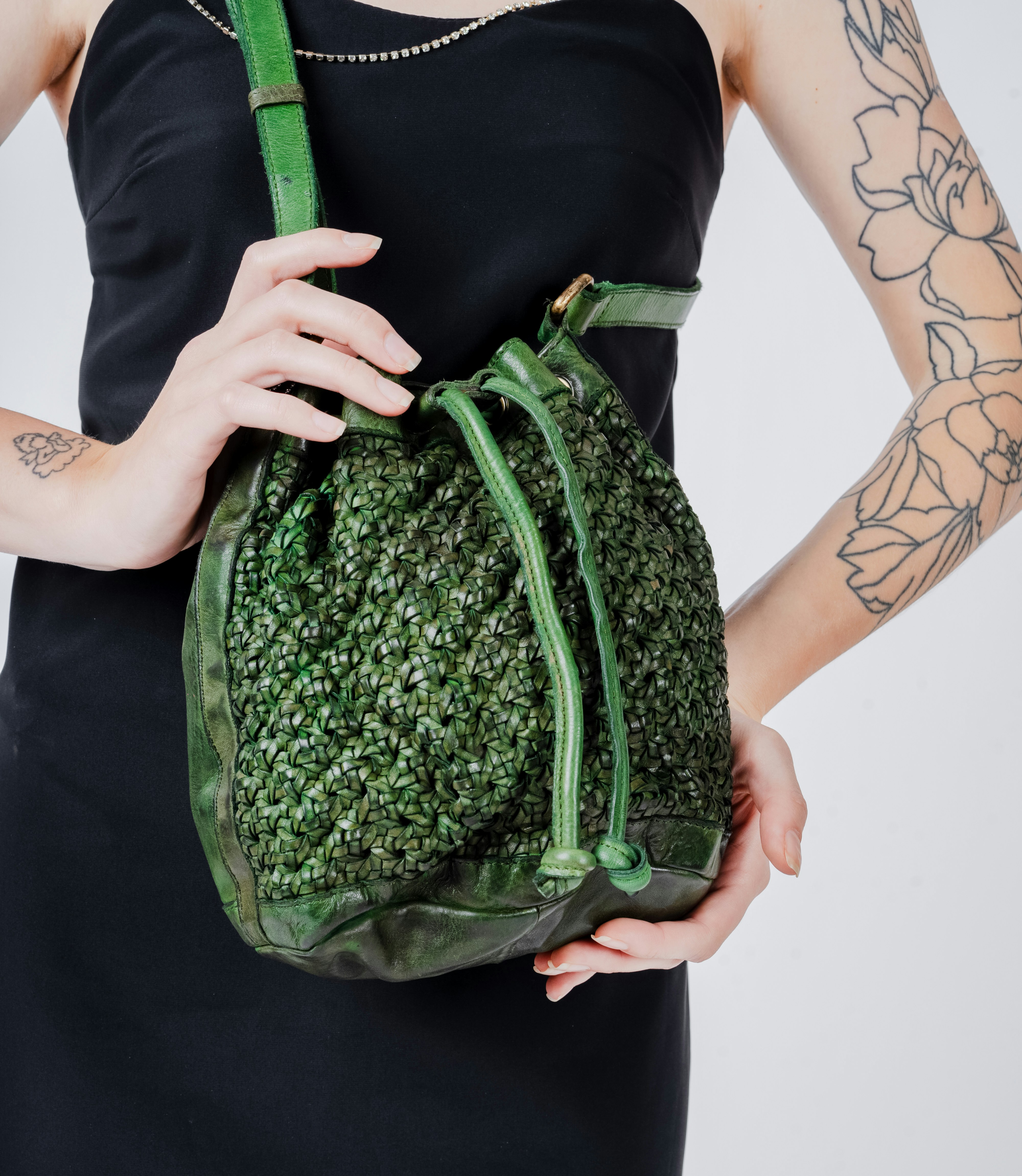 Emerald-Woven Bag: Texture, Drawstring, and Inked Silhouette
