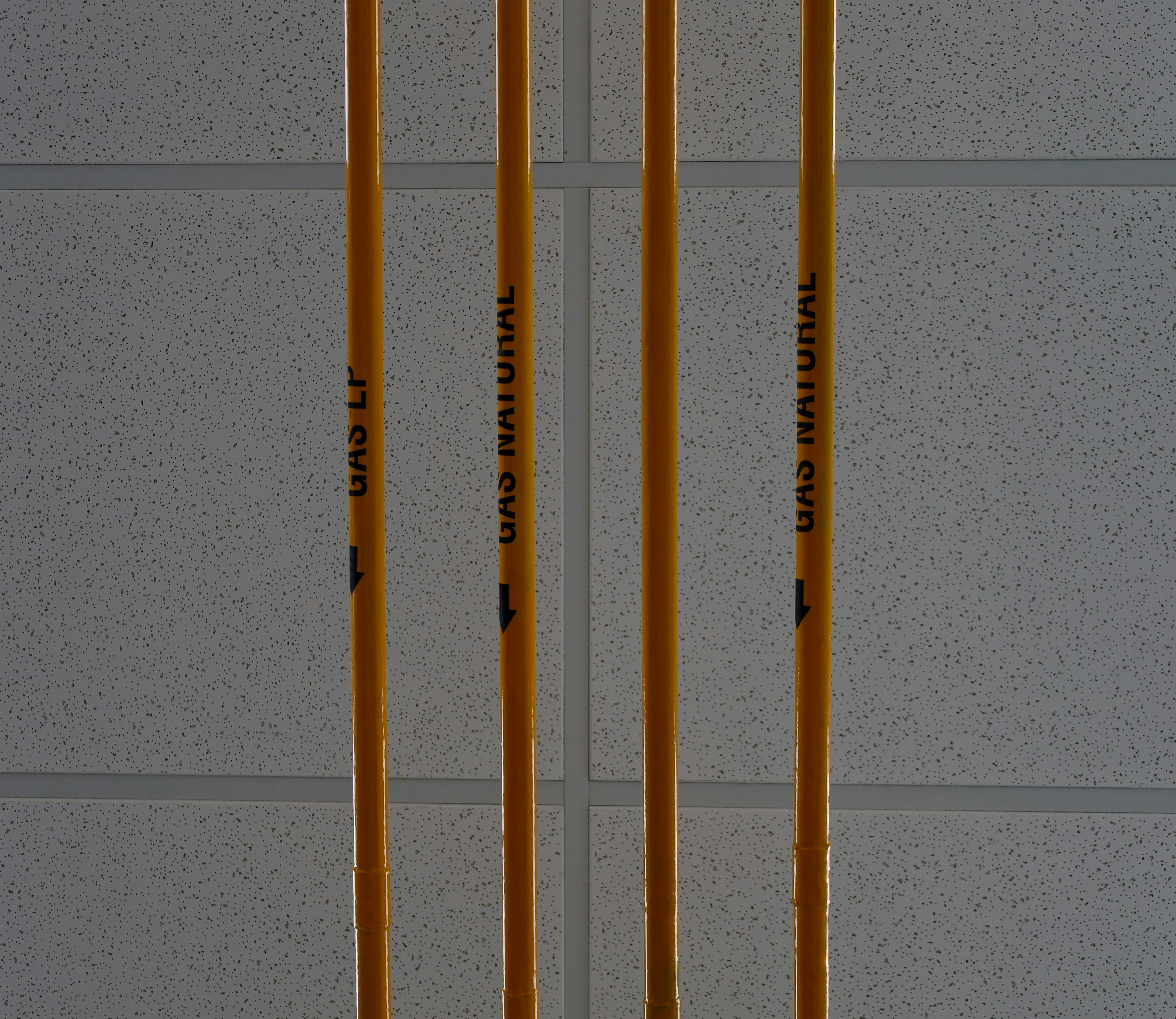 A couple of yellow poles sitting next to each other photo – Free Gas ...