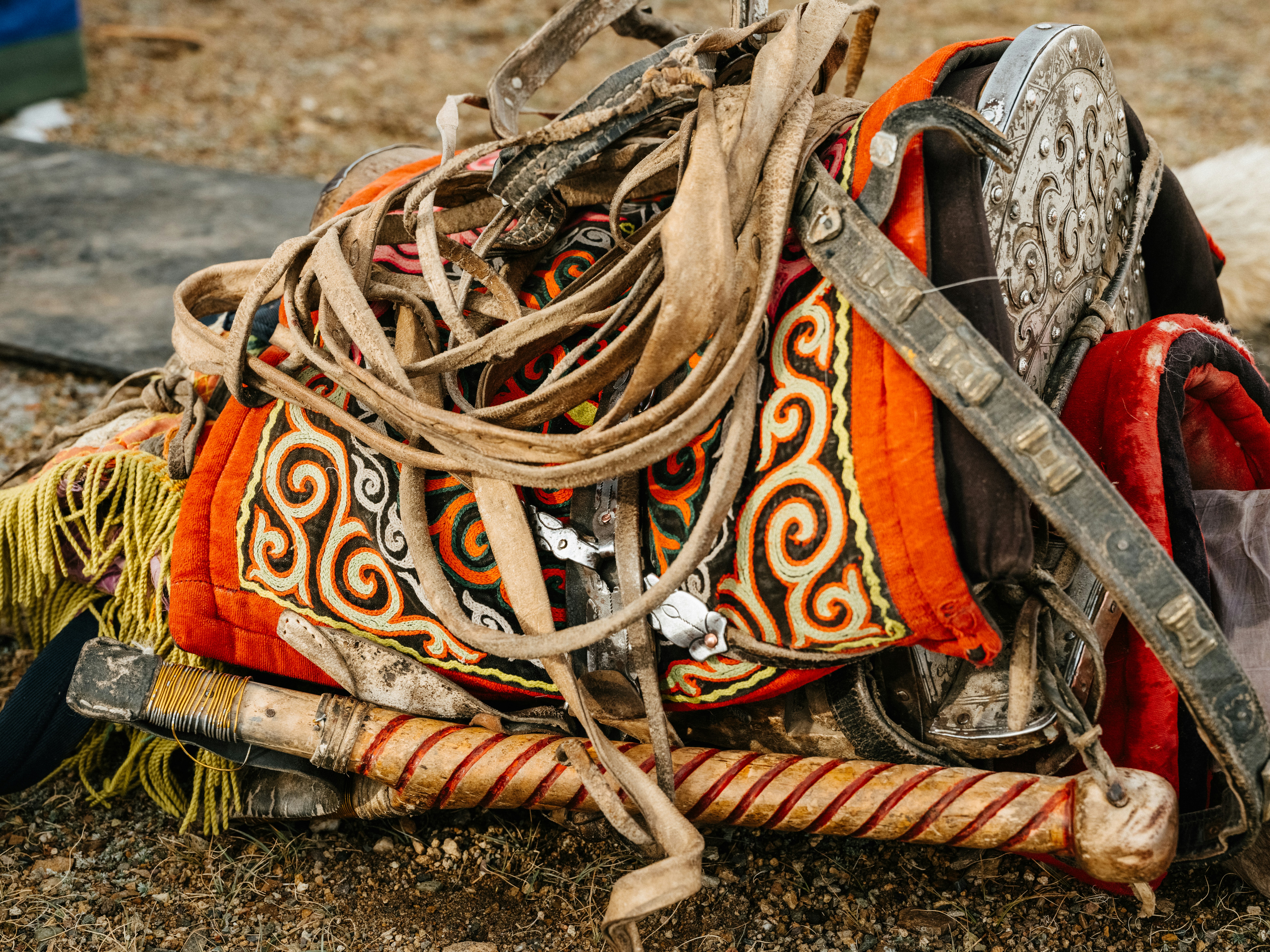 Saddlebag | a pile of old, worn, and used items sitting on the ground