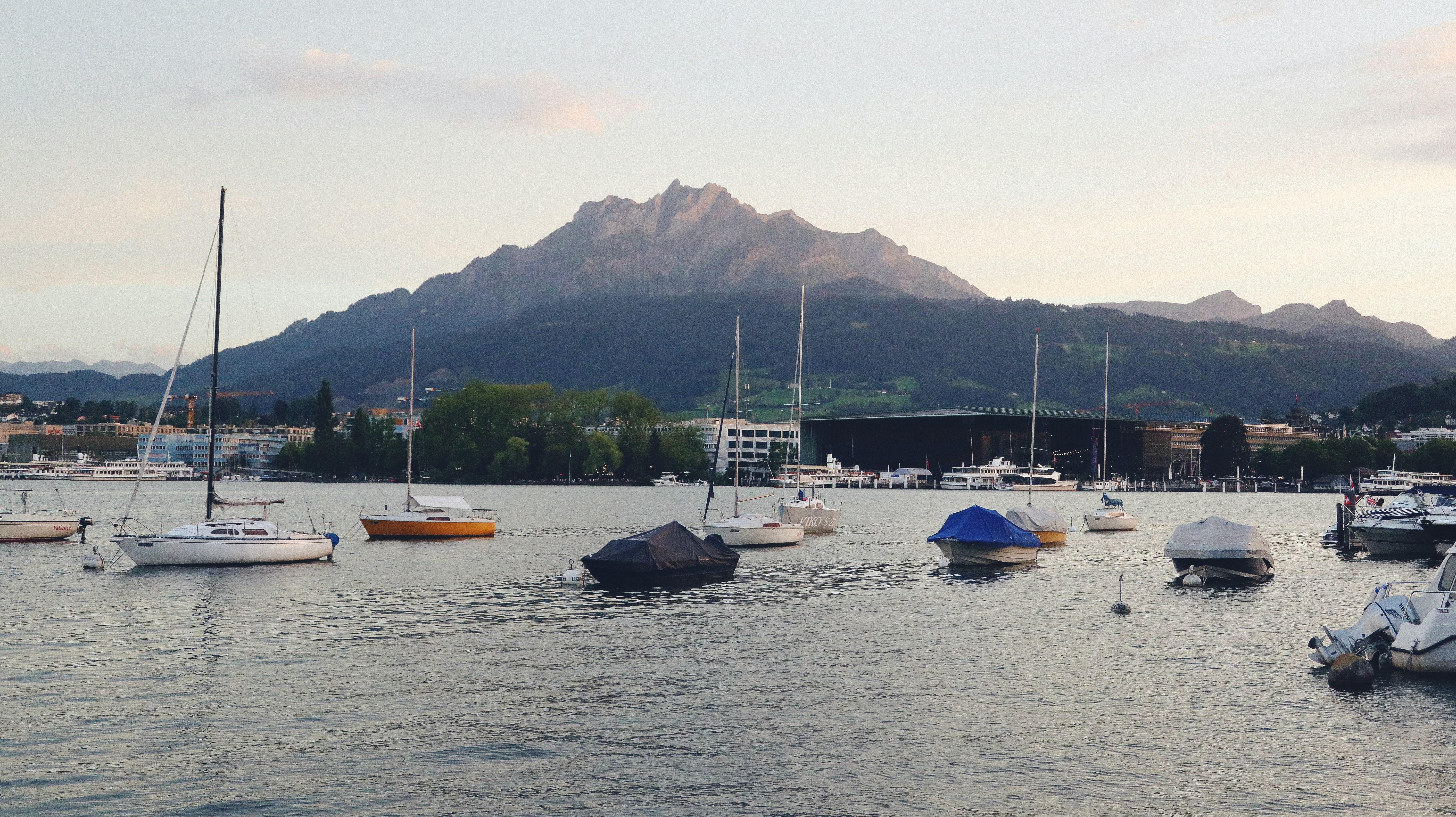 A group of boats floating on top of a lake photo – Free Switzerland ...