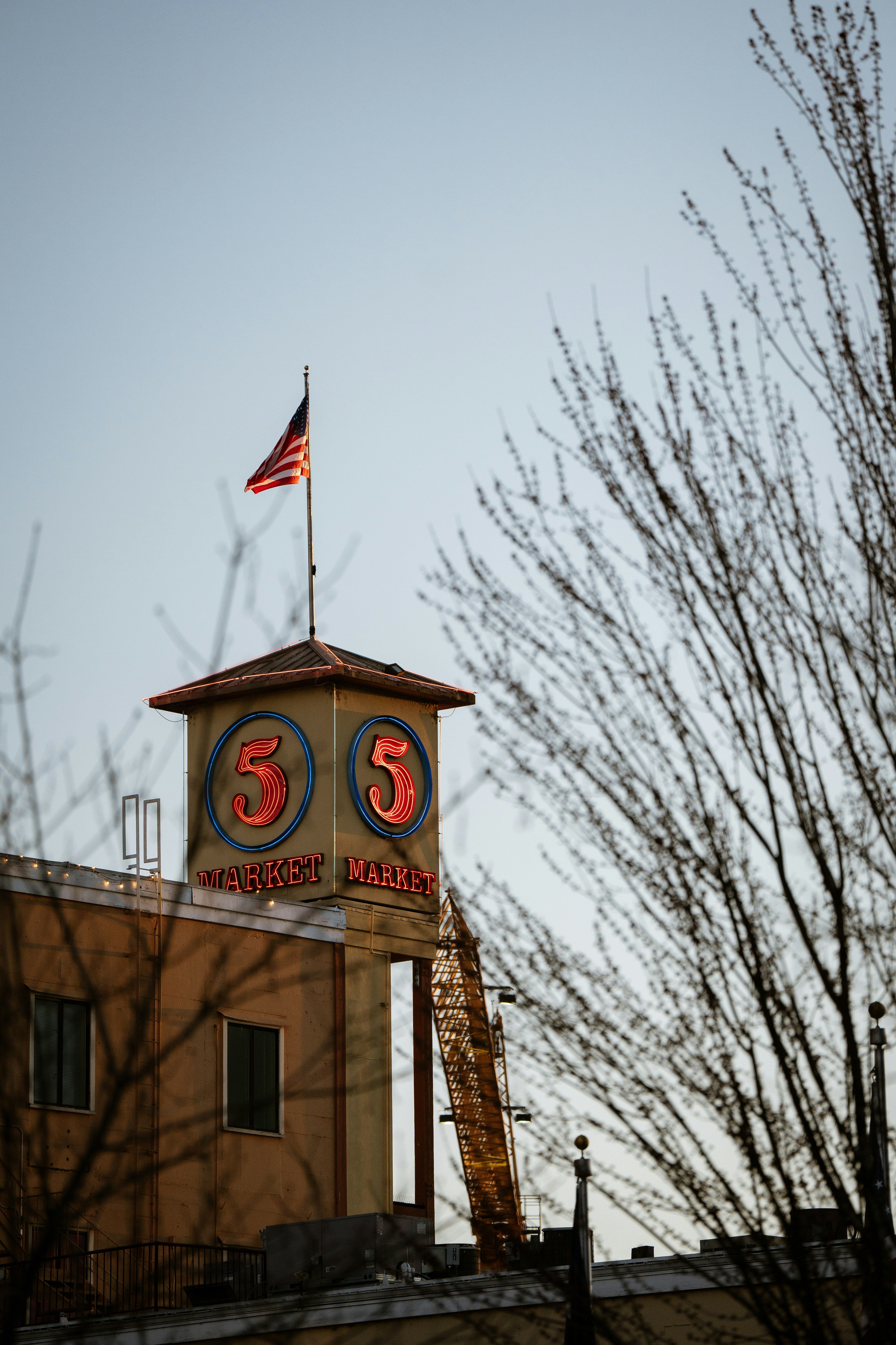 Twin Five Sign Tower: Neon Numerals Guarding a Corner Market