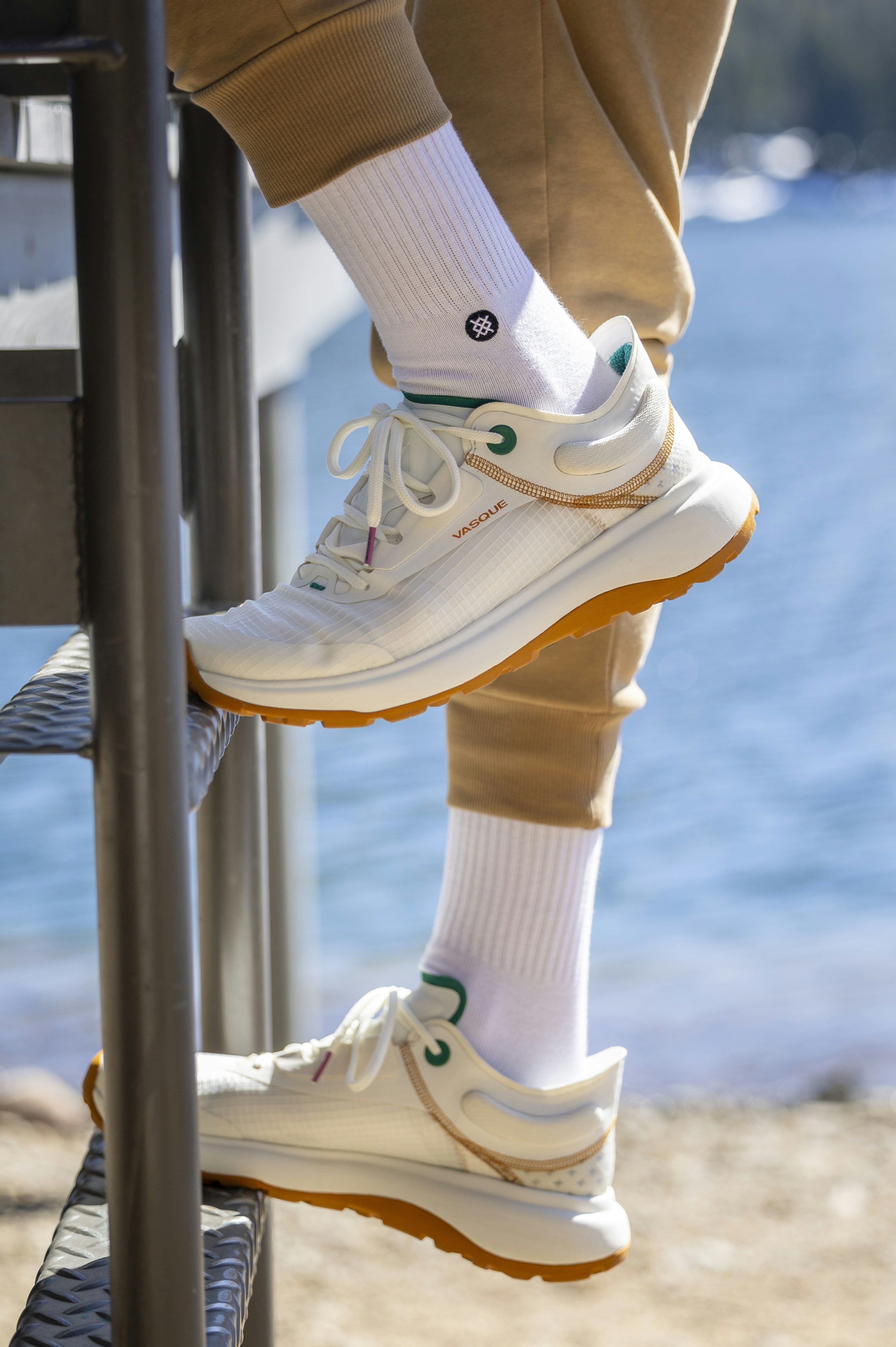 Sunlit Step: White sneaker perch on a railing by the waterfront
