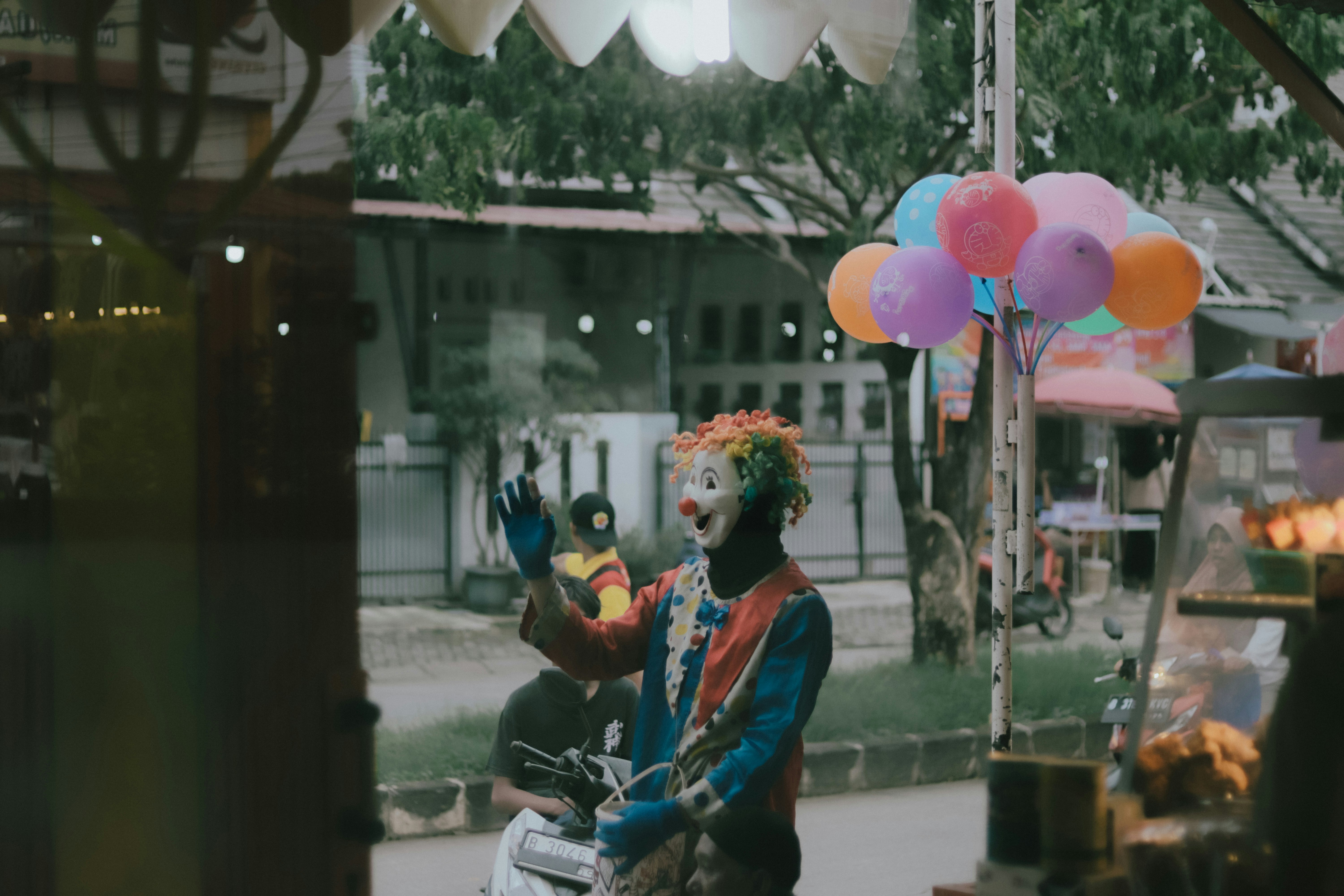 A clown riding a motorcycle on a city street photo – Free West java ...