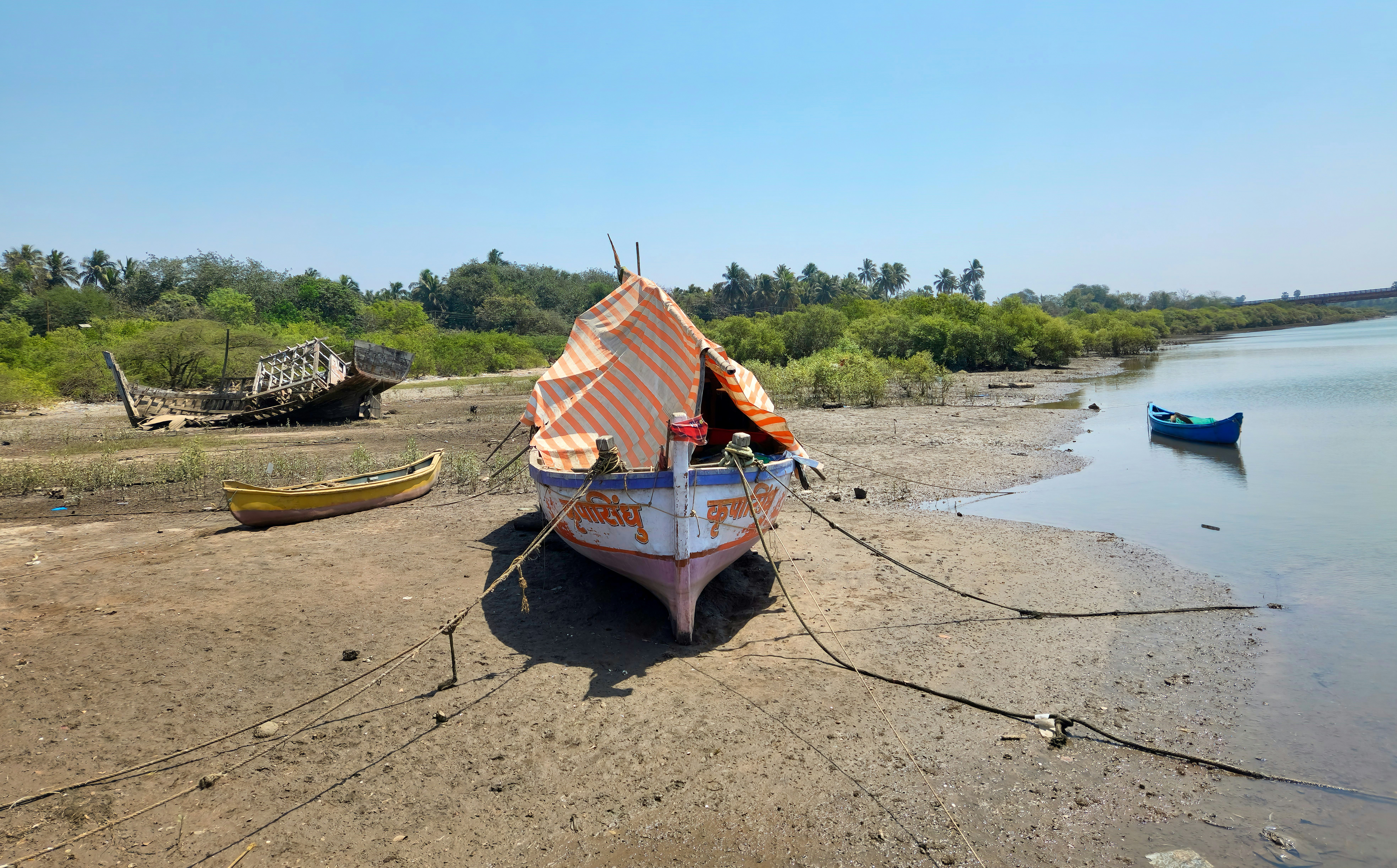 Beached Boat Wake: A Striped Sail and Quiet Estuary