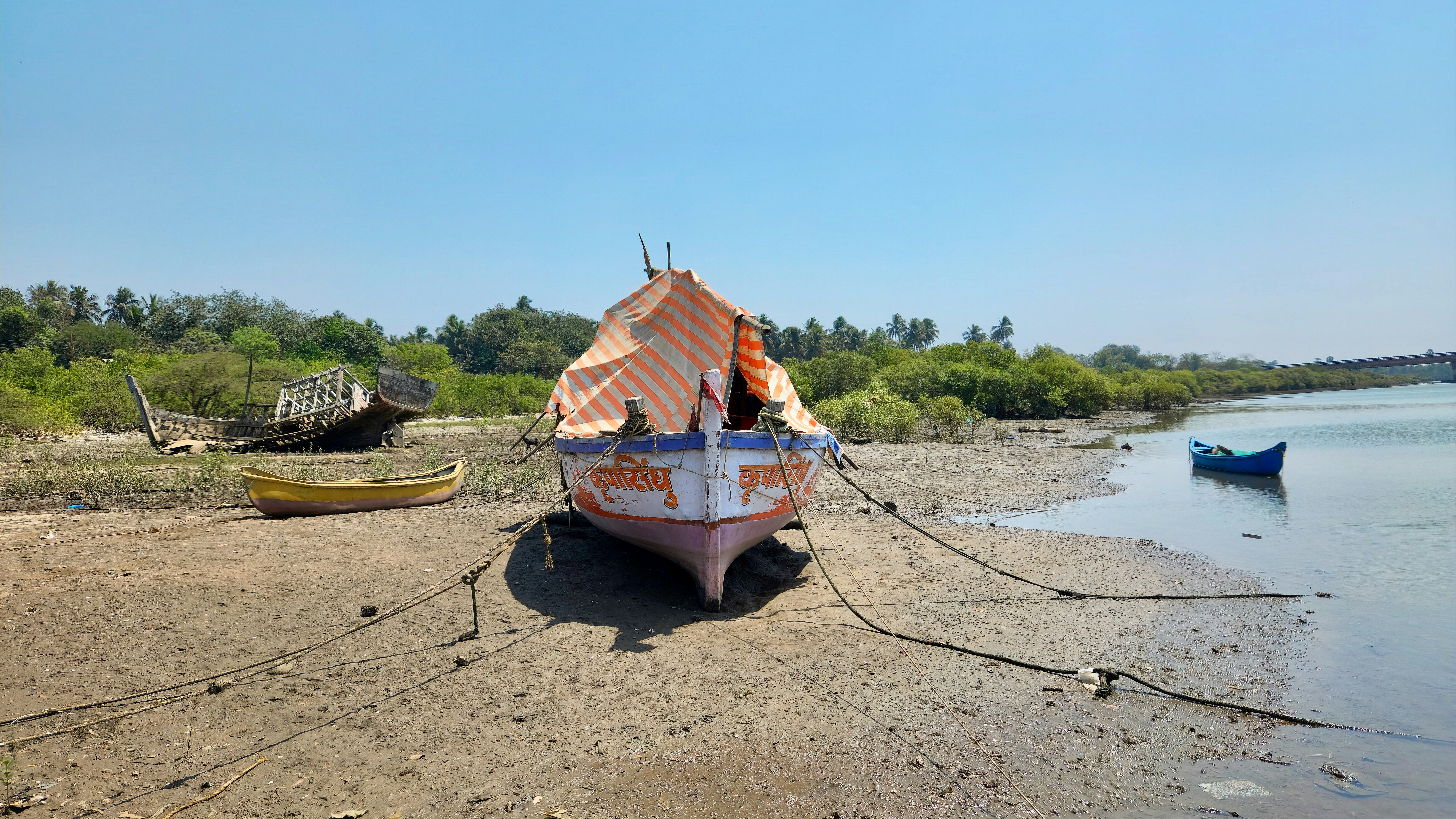 Stripped Sail on the Mudflat: A Quiet Boat Portrait by the Shore