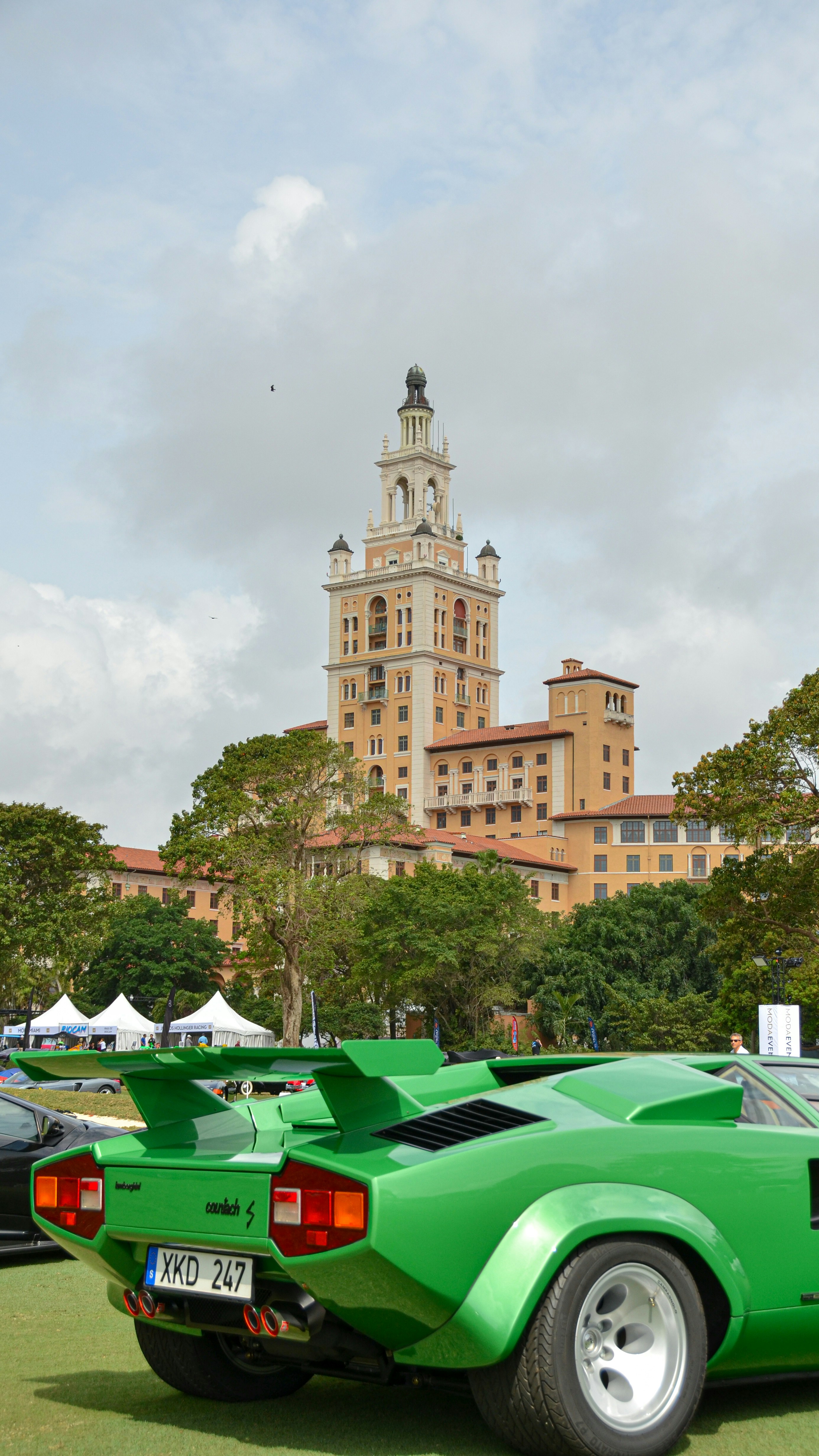 Emerald Lamborghini at the Foot of a Historic Bell Tower