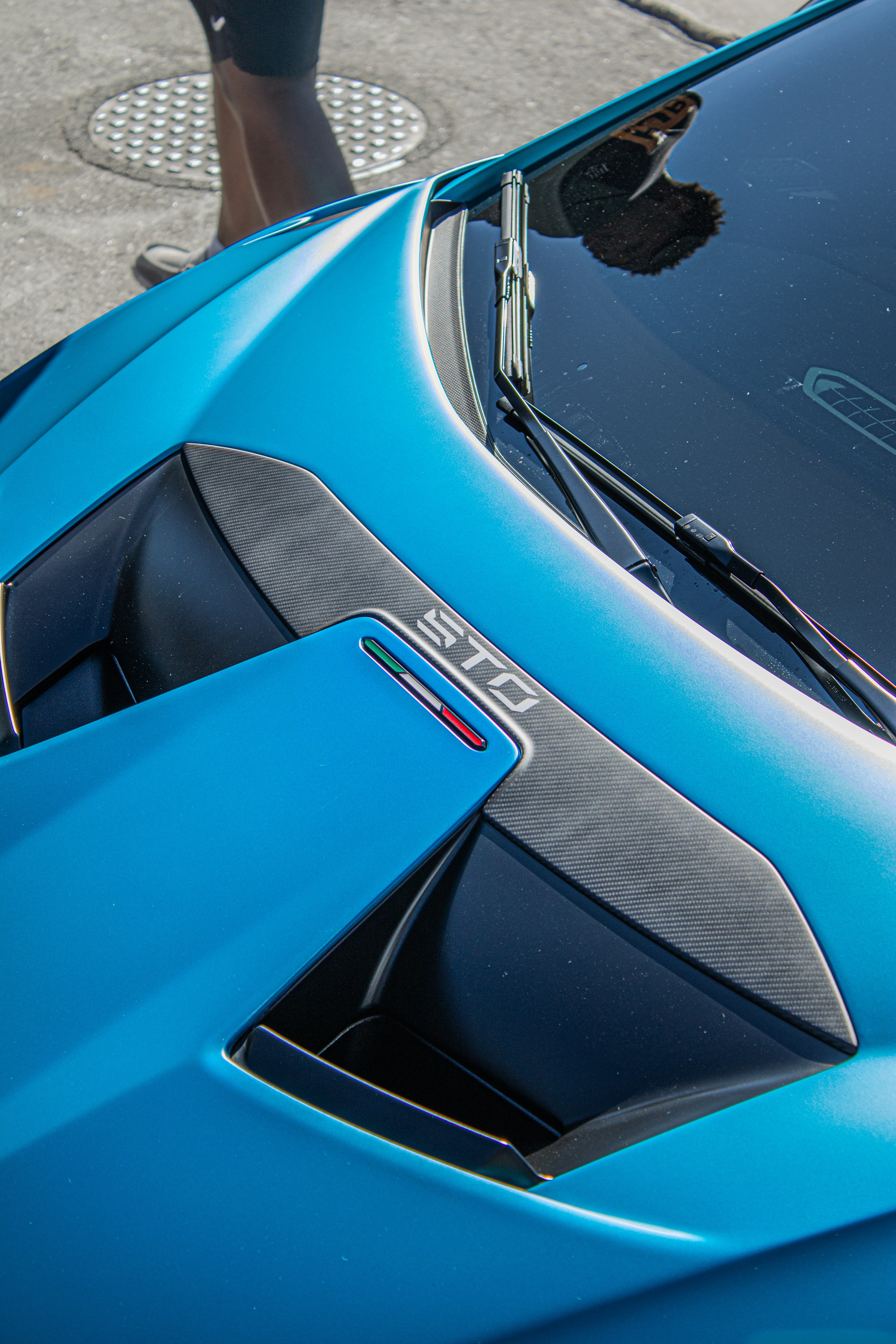 A close up of the hood of a blue sports car photo – Free Lamborghini ...