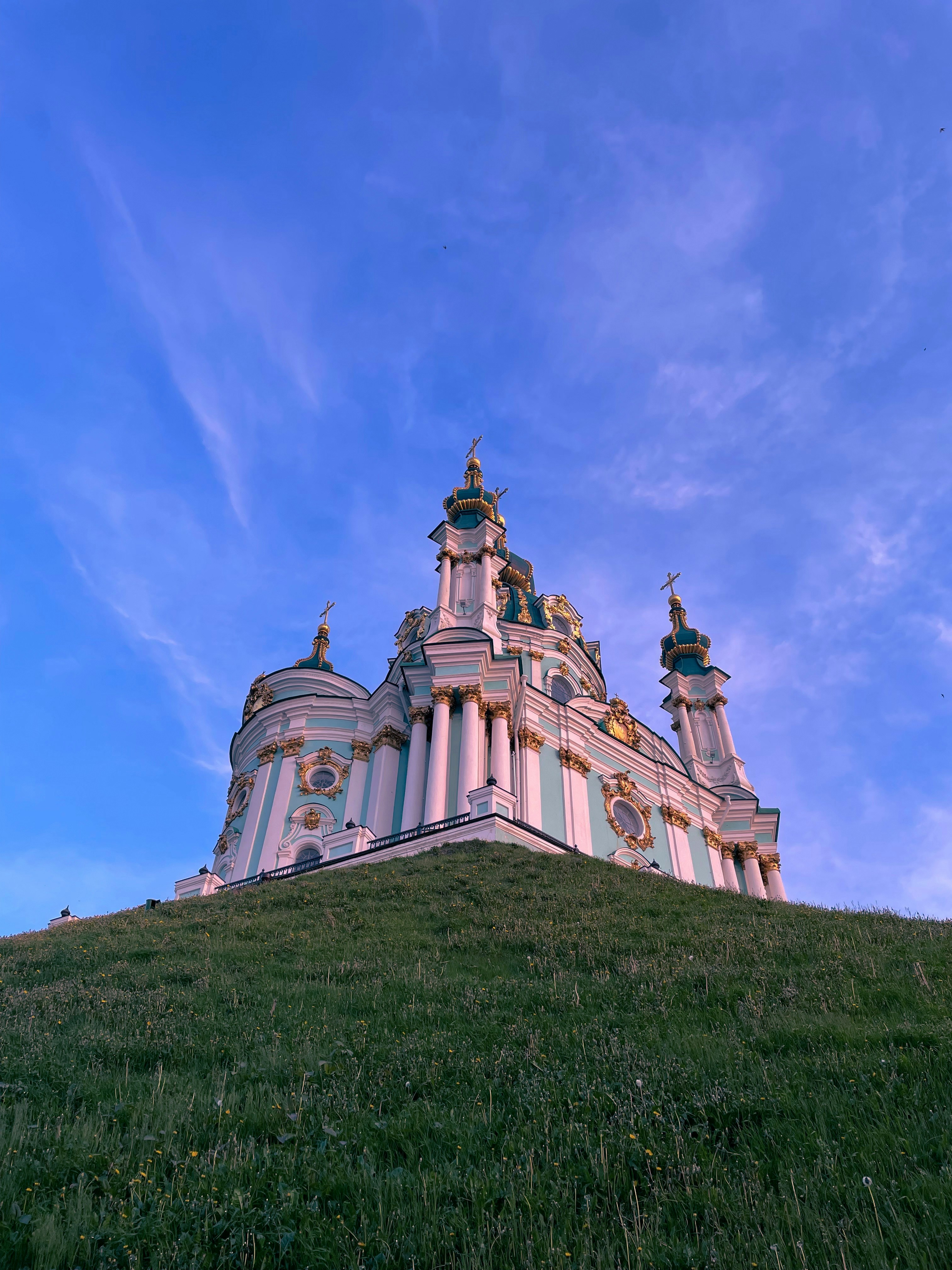 Sunlit Cathedral Crest: A Stub of Sky Over a Hilltop Shrine
