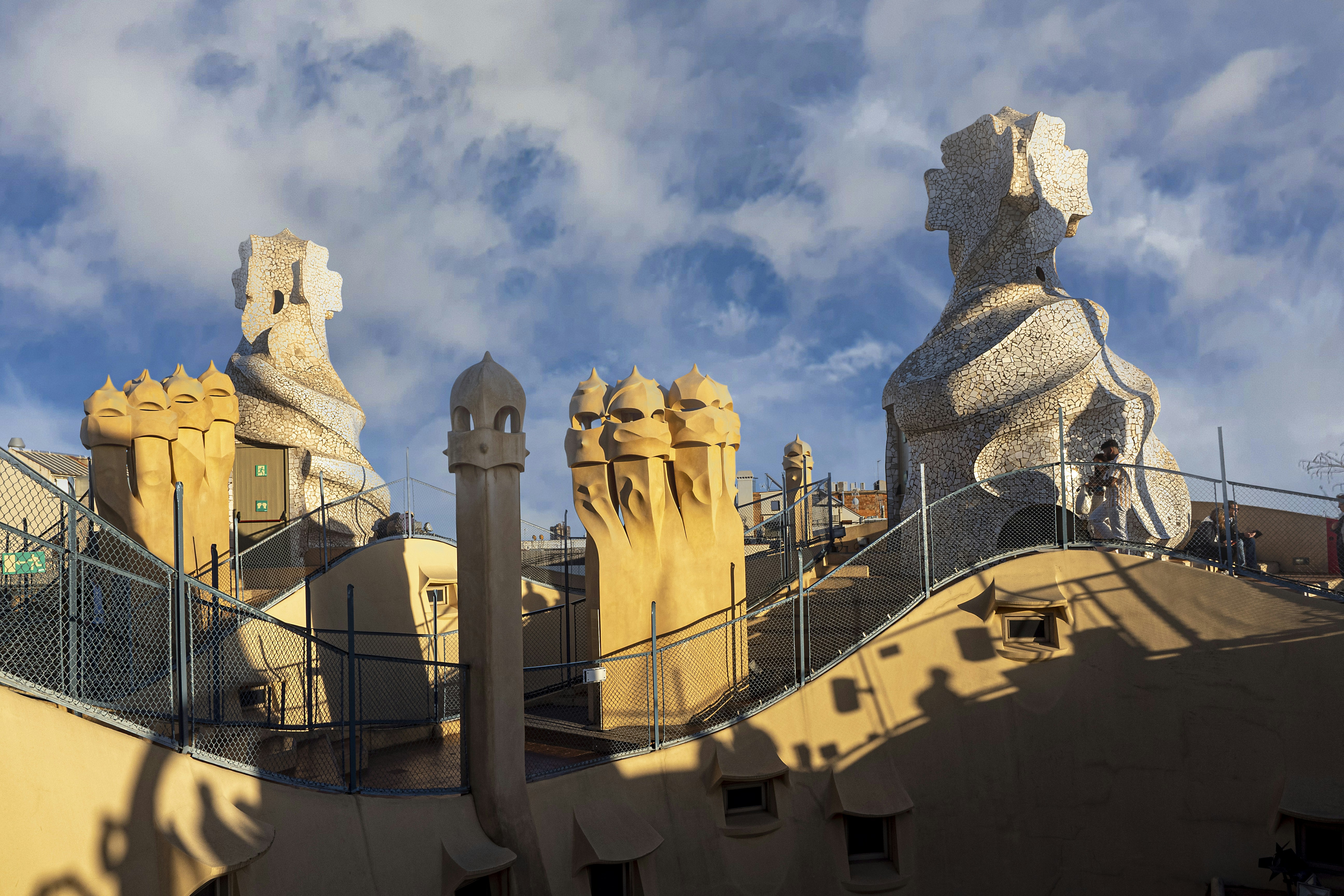 Curved Chimneys and Stone Figures at Snapped Sunlit Rooftop