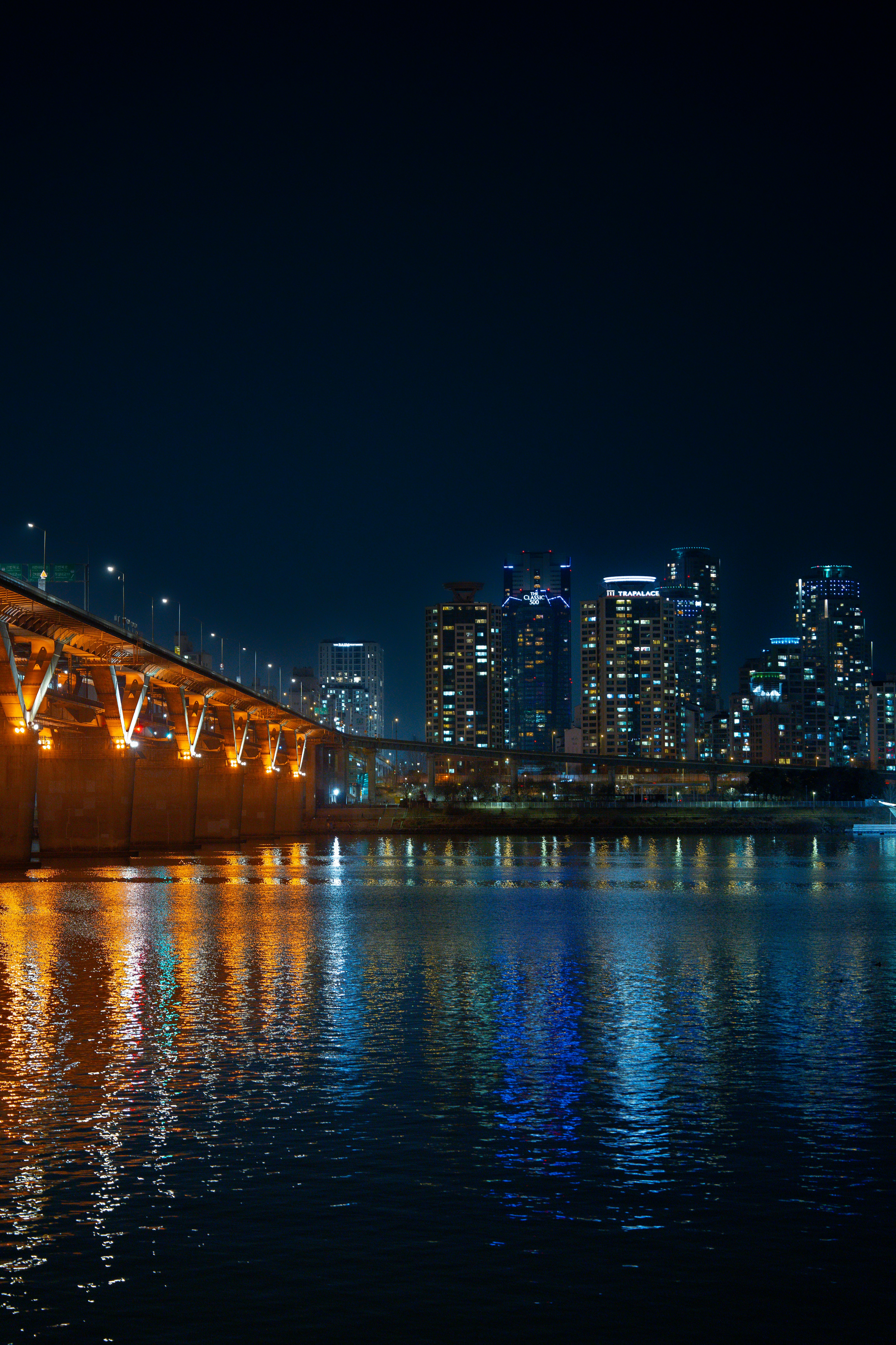 A large bridge over a body of water at night photo – Free Night Image ...