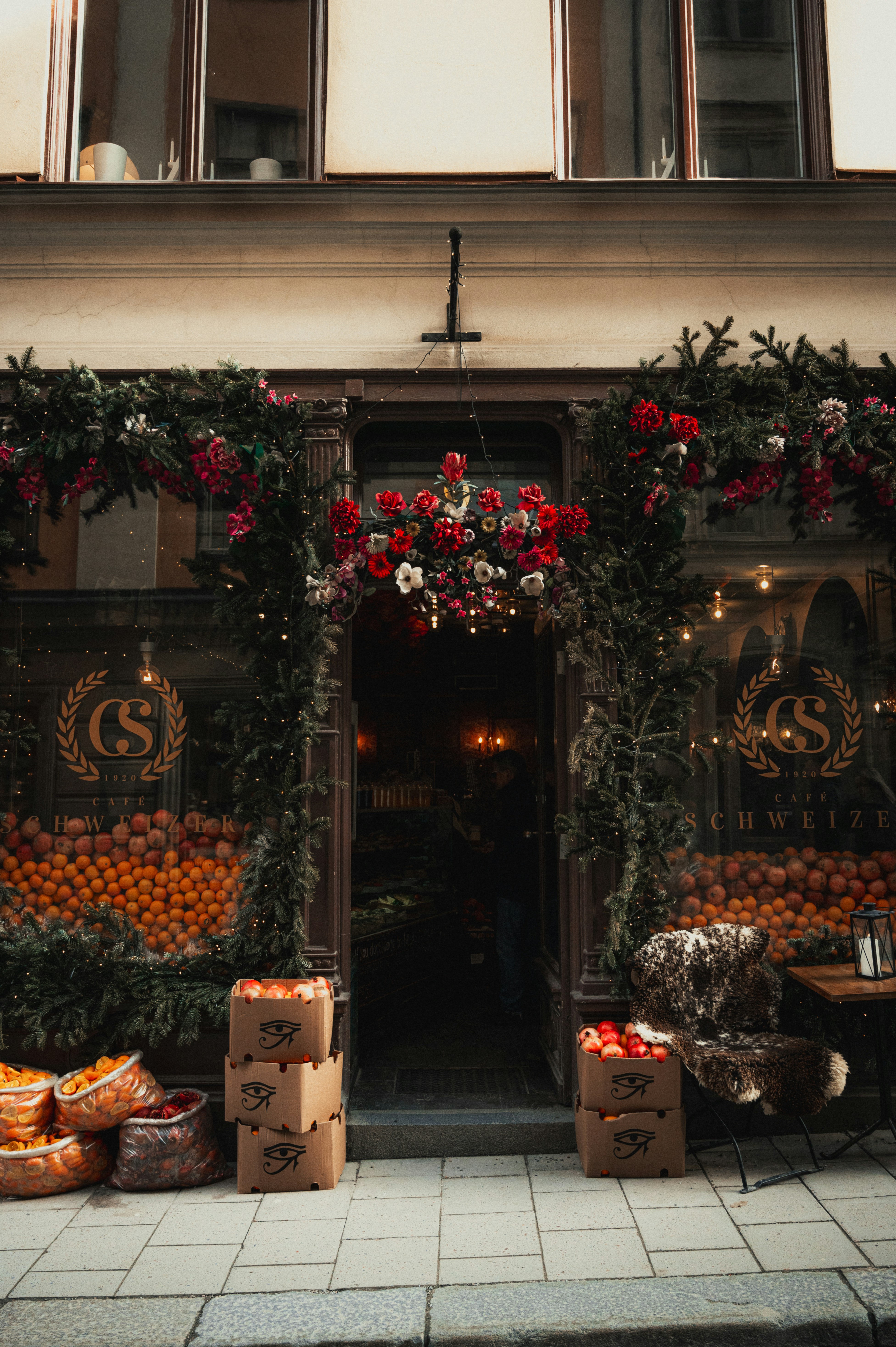 Floral Portal to a Quiet Market: A Seasonal Storefront Framed by Verdant Garlands