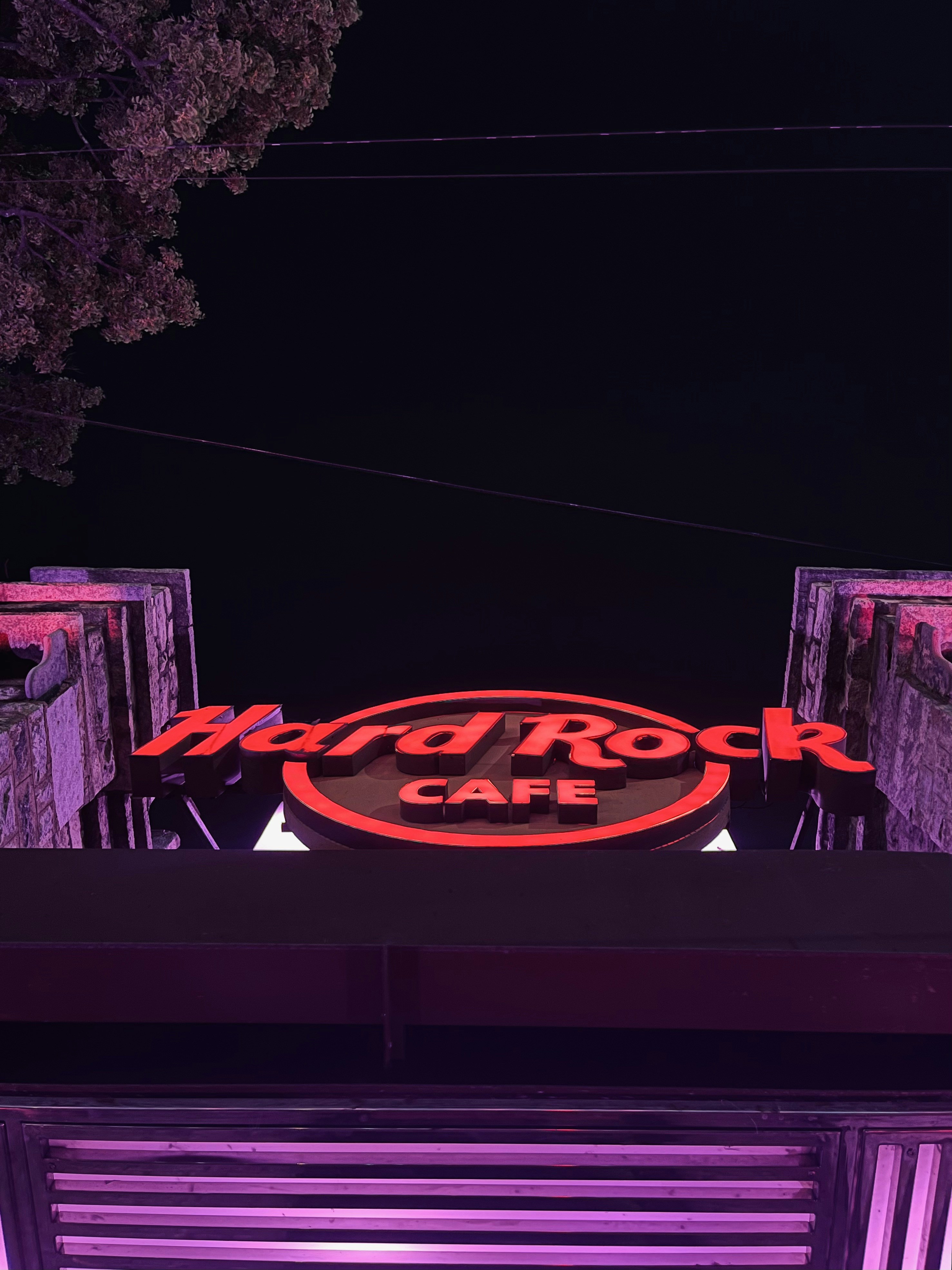 Neon Sign Overhead at Night: Hard Rock Café Entrance