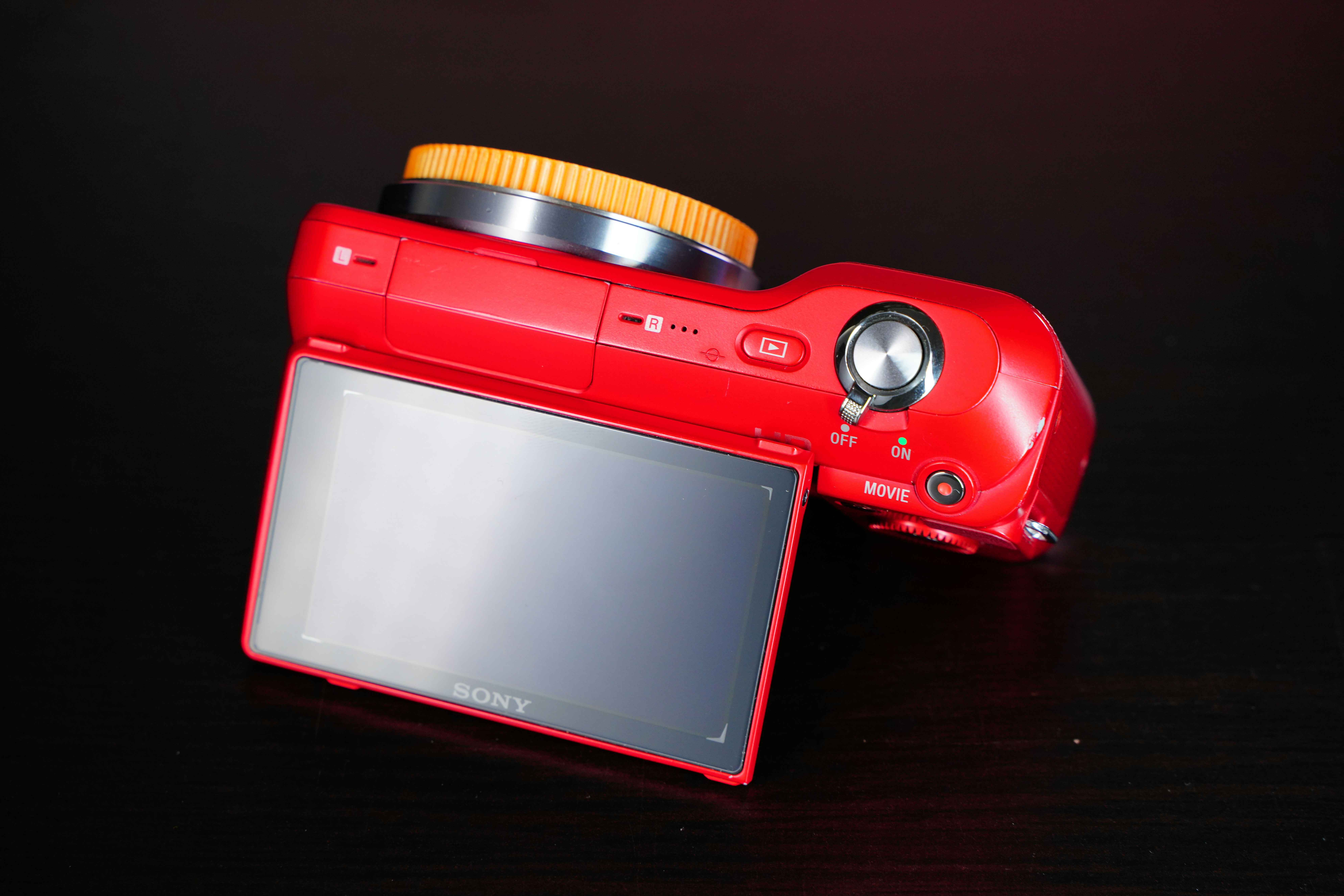 This Sony NEX-3 in radiant red captures more than photos—it seizes the gaze with its vivid charm and tech allure.