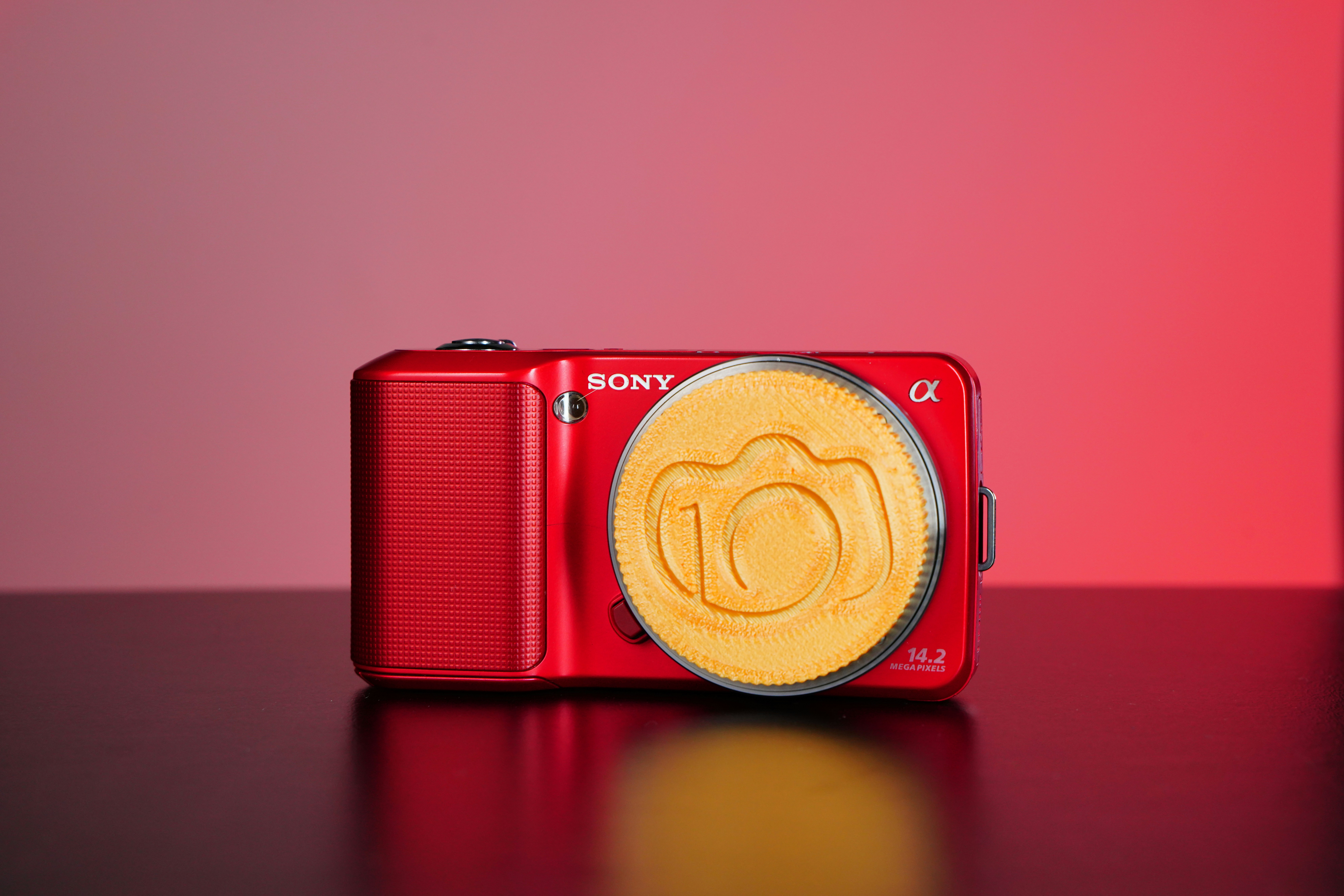 A red camera sitting on top of a table photo – Free Sony alpha Image on ...