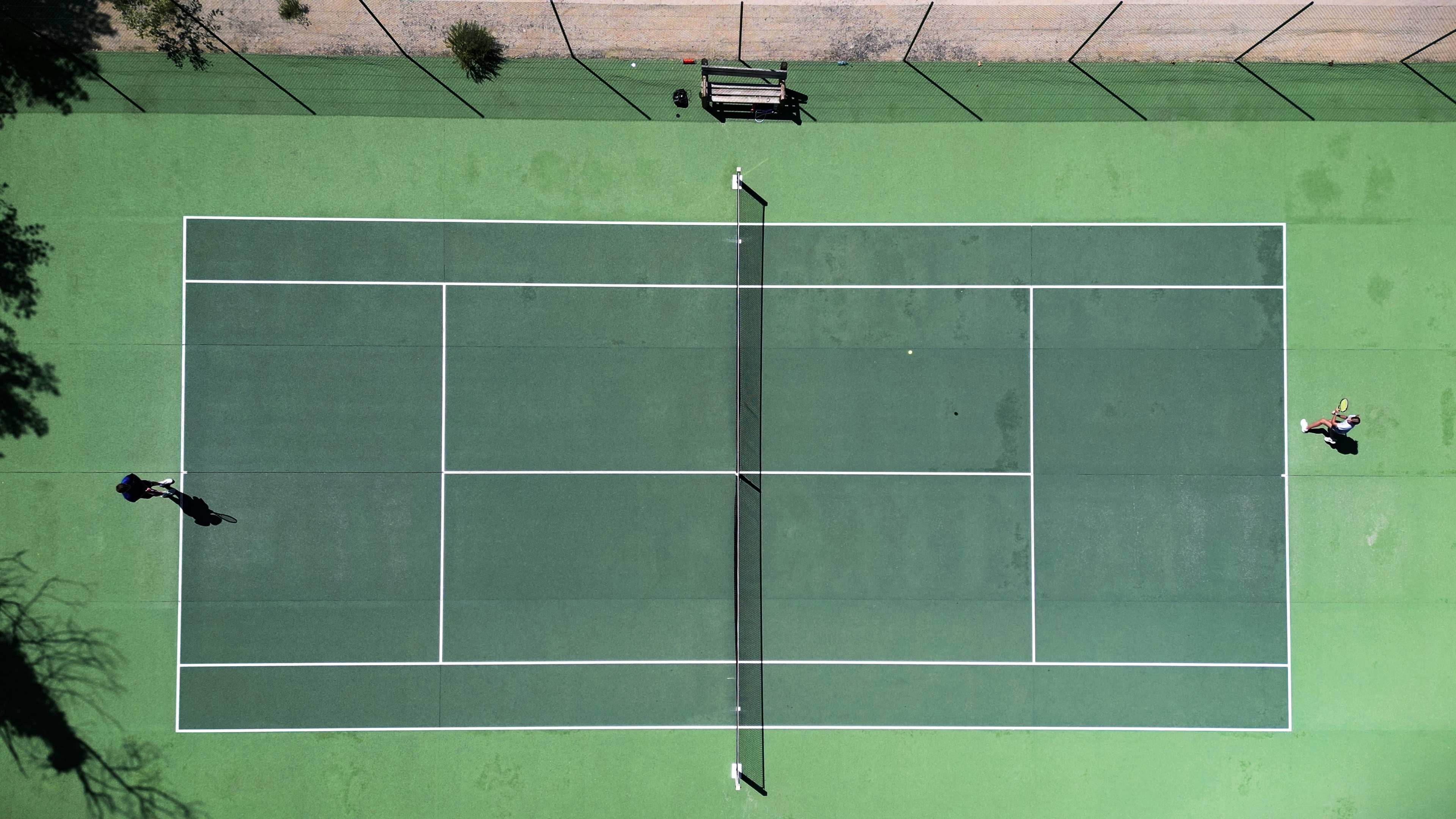 Two people playing tennis on a tennis court photo – Free Green Image on ...