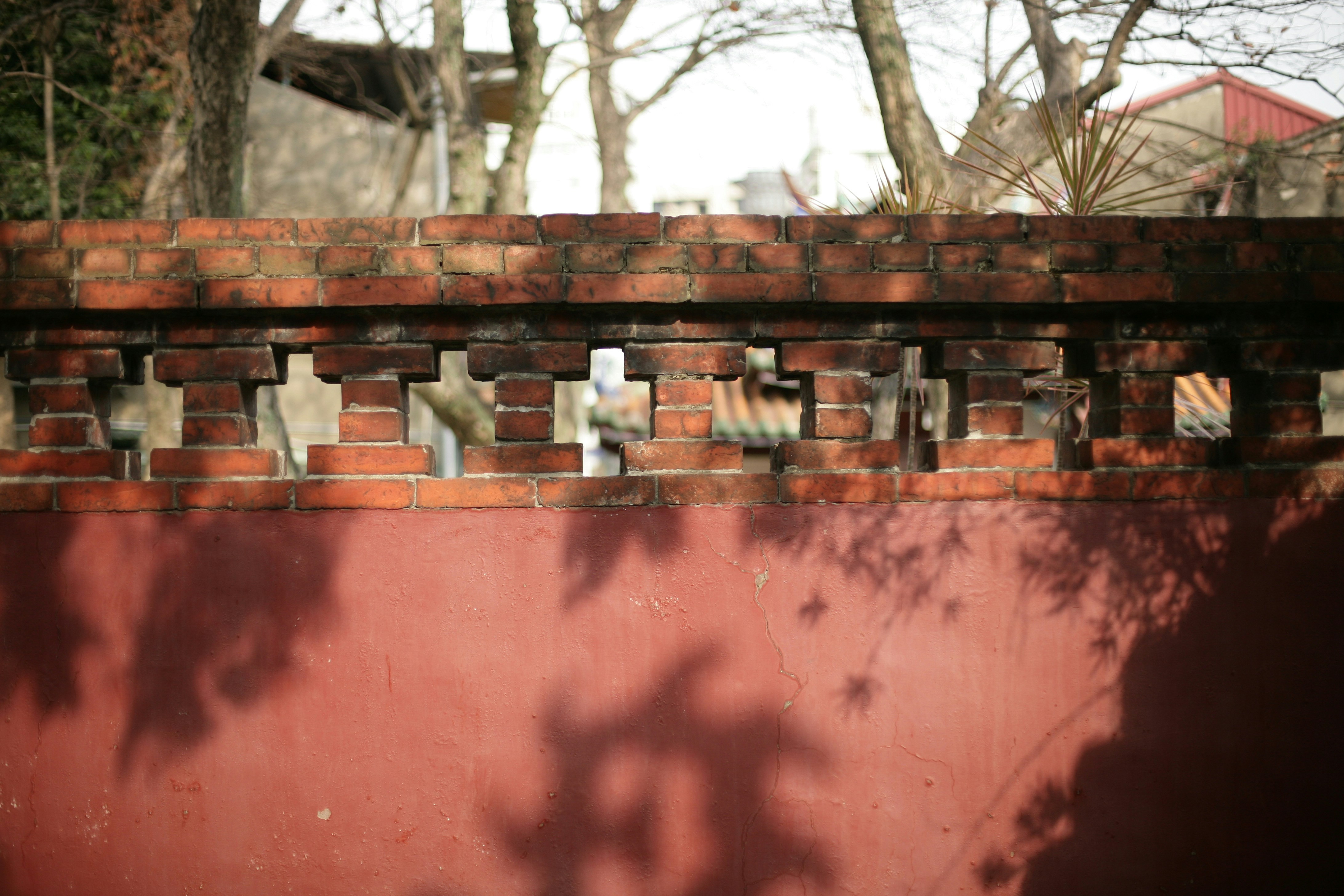 Brick Lattice Parapet and Shadow Play on a Salmon Wall