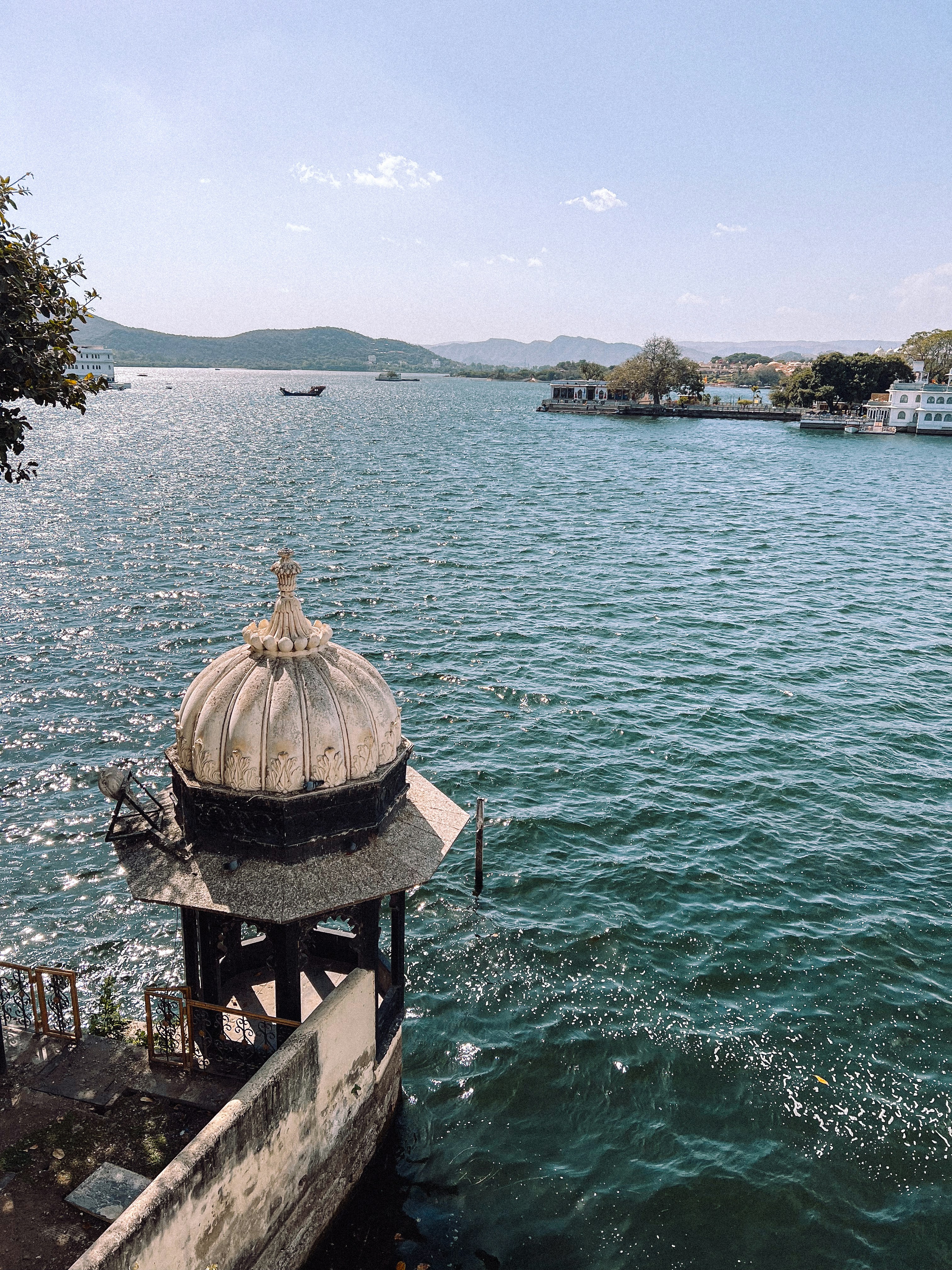 Domed Pavilion Over Calm Waters: A Lakeside Landmark Framed by Distant Hills