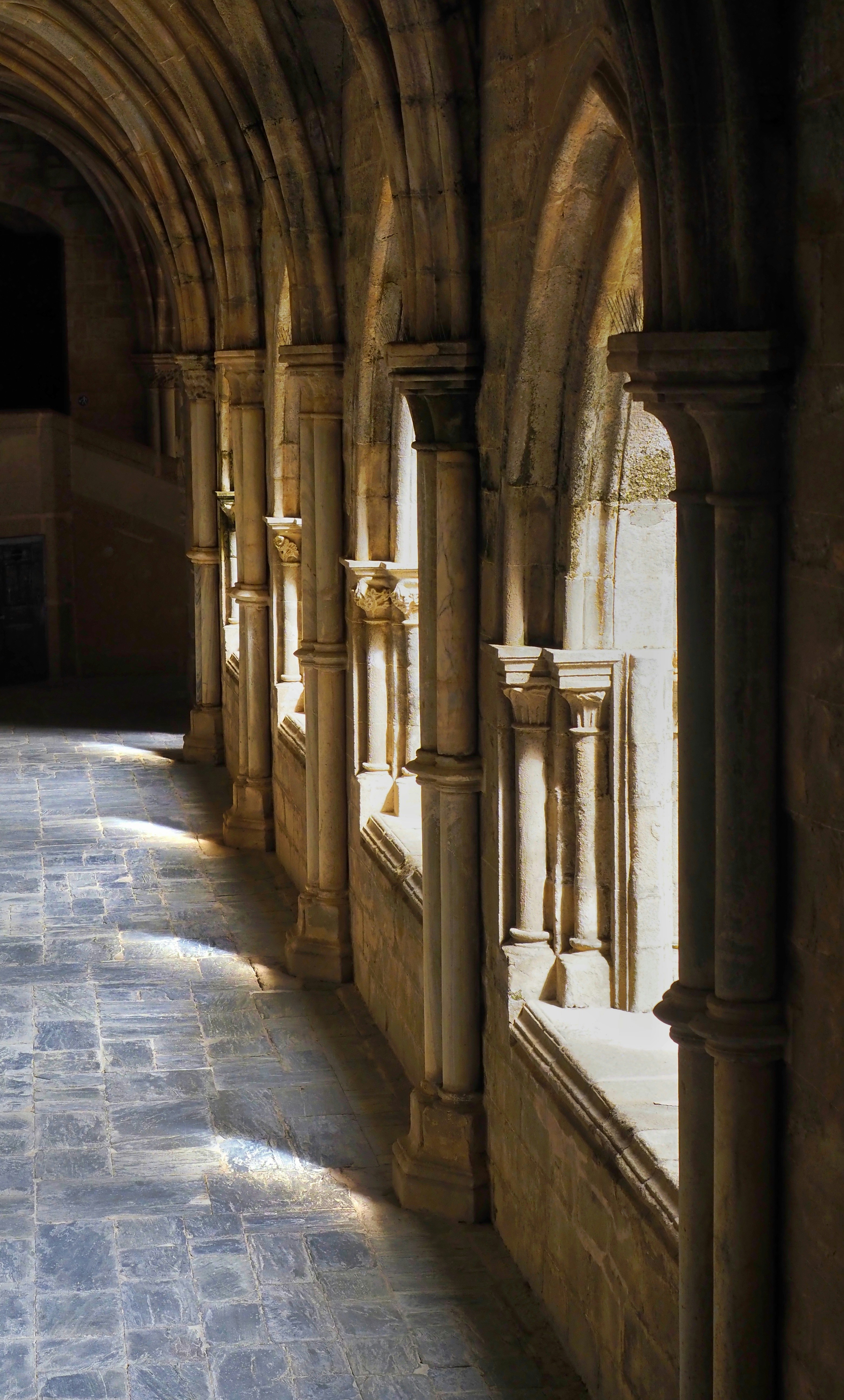 A row of stone arches in a building photo – Free Evora Image on Unsplash