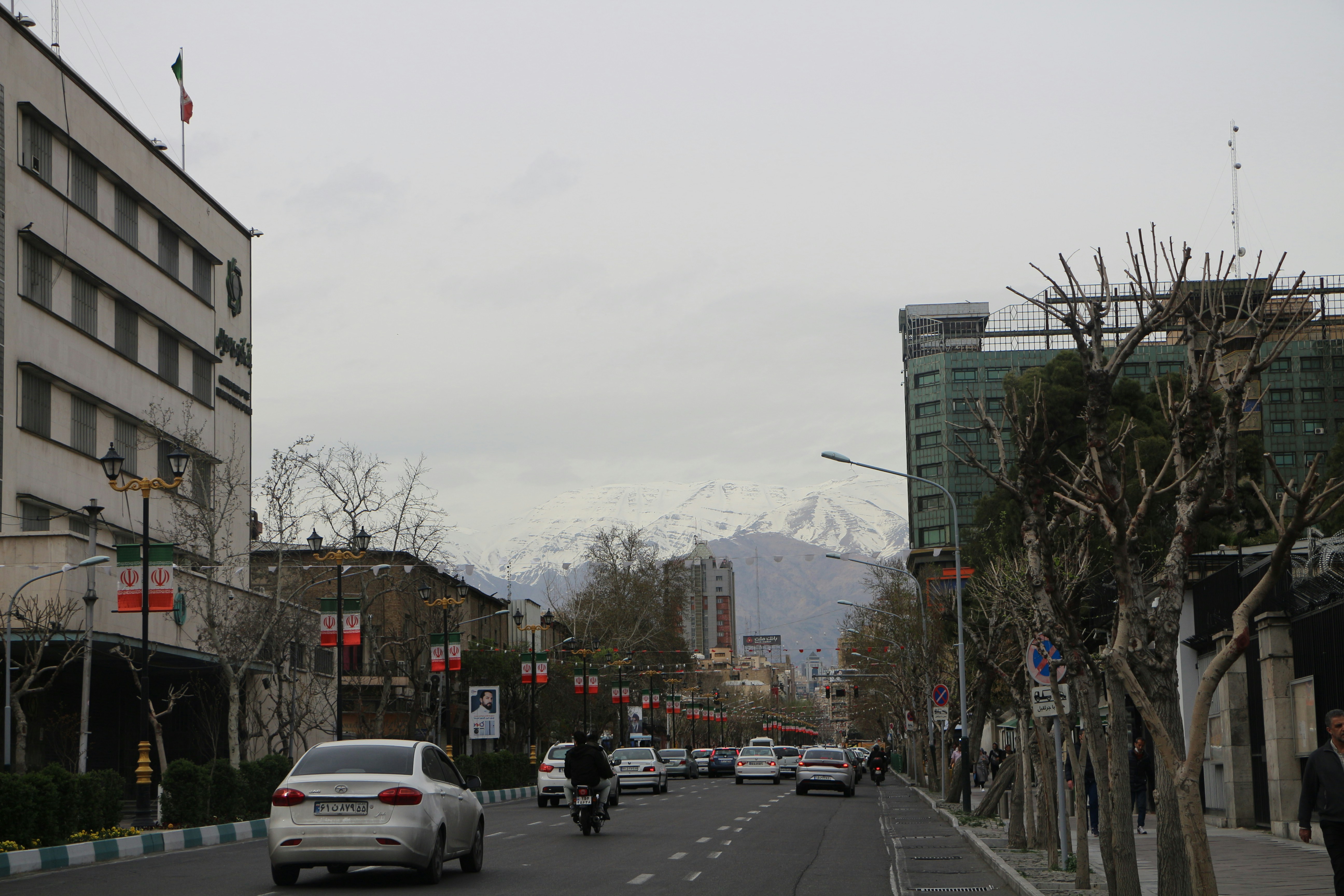 Convergence on a City Street Toward a Snow-Capped Horizon