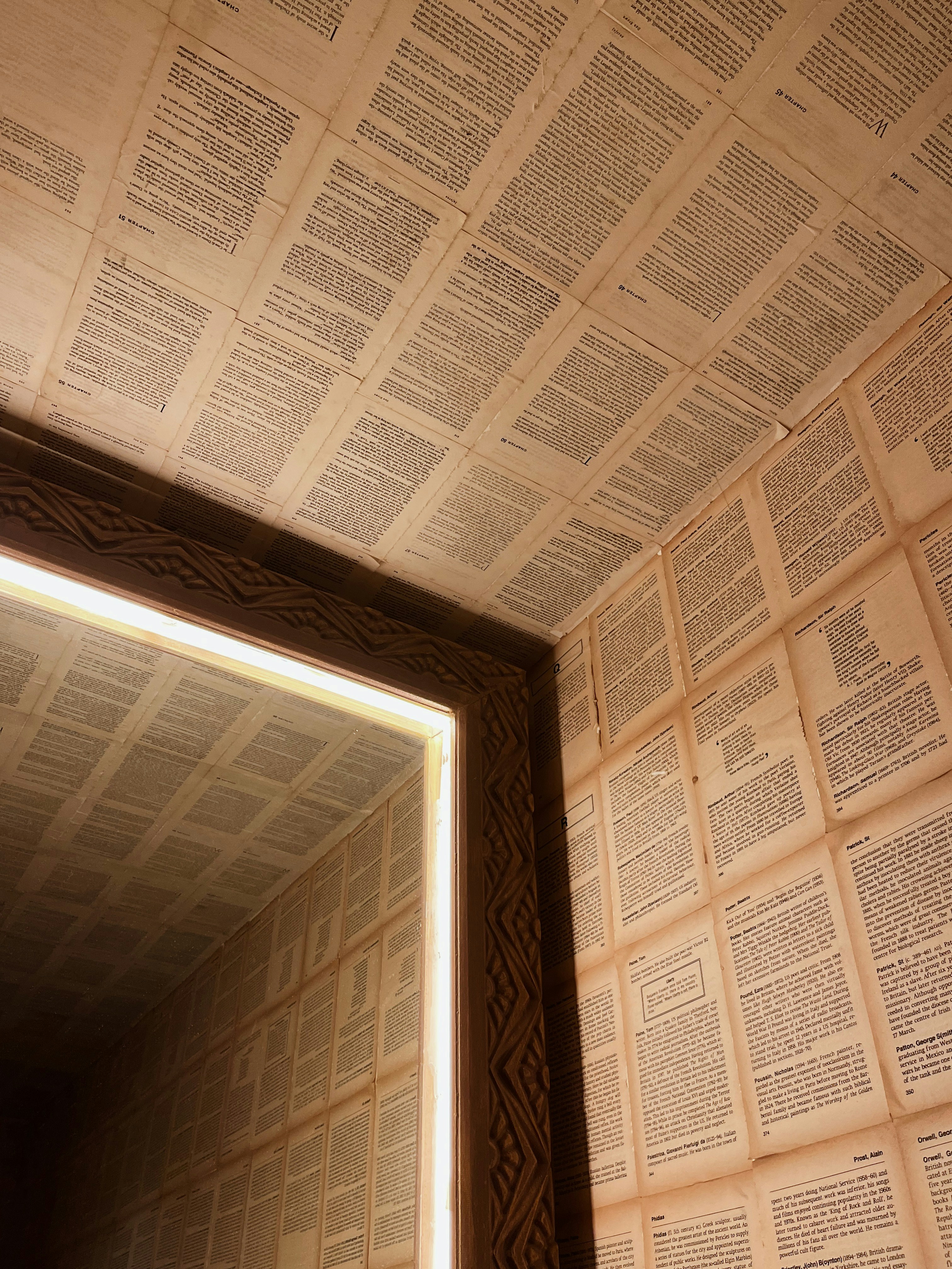 a bathroom mirror sitting on top of a wooden counter