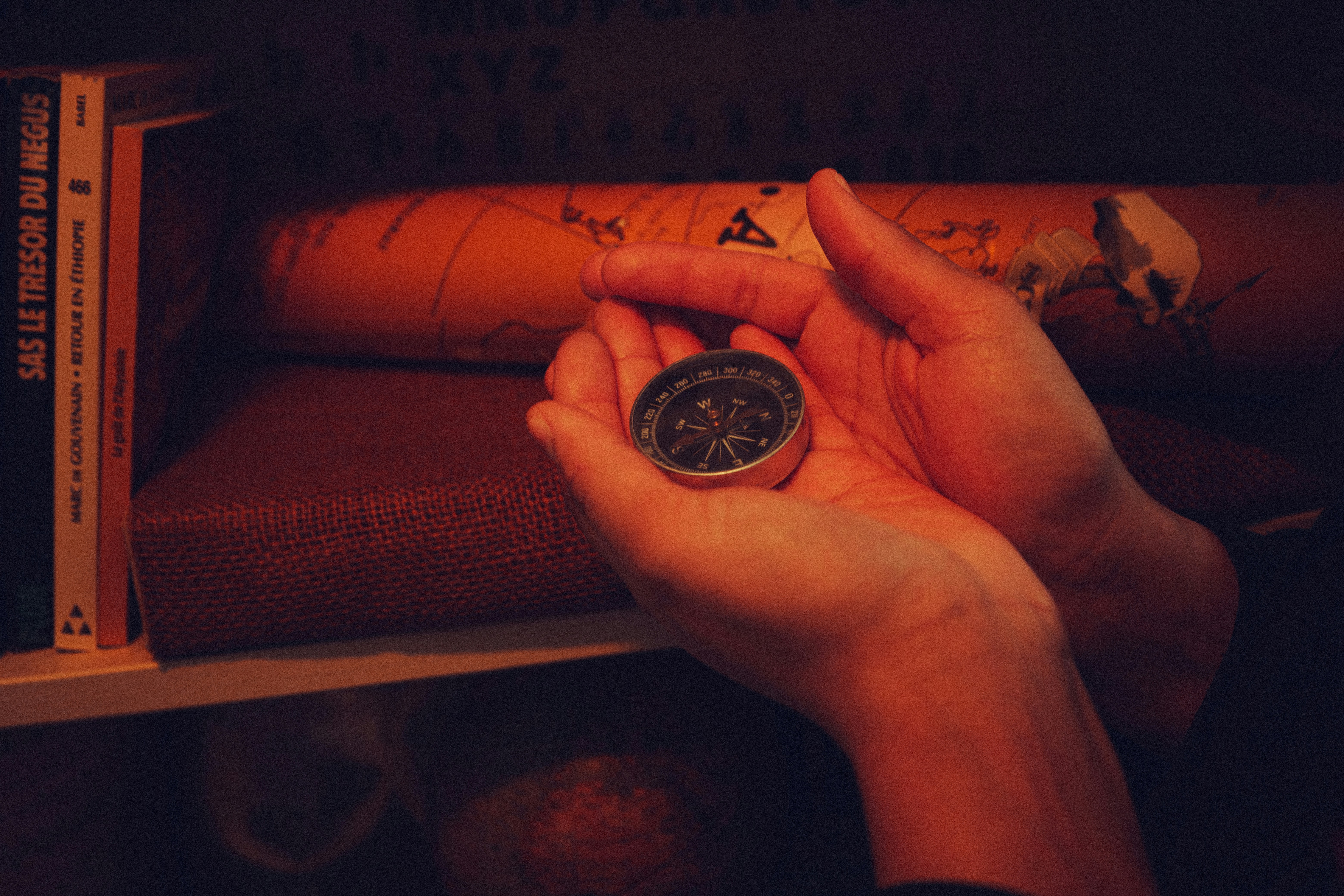 Amber-Held Time: Hands cradle a pocket watch on a dim library shelf