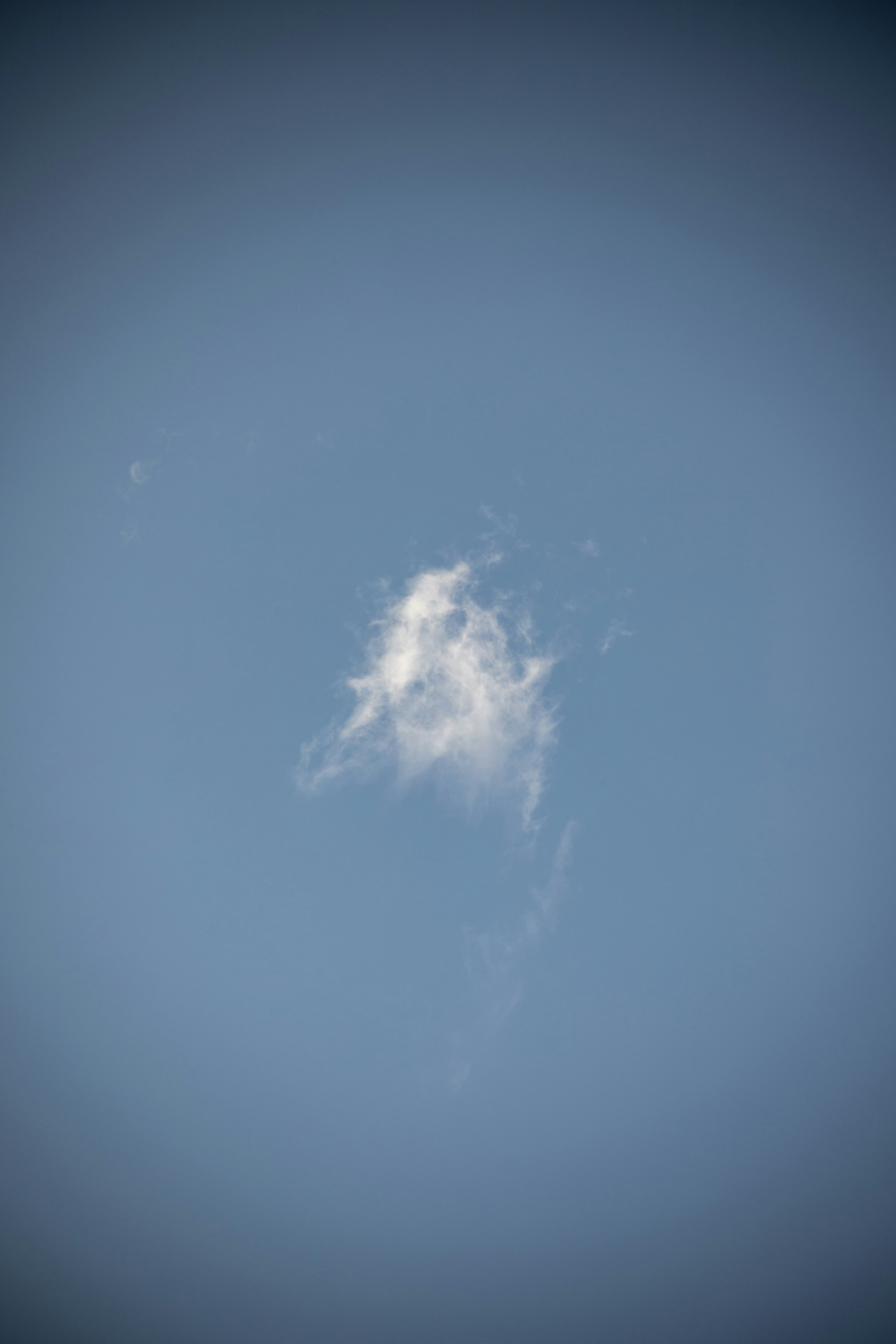 Lone Cloud in a Quiet Blue Expanse