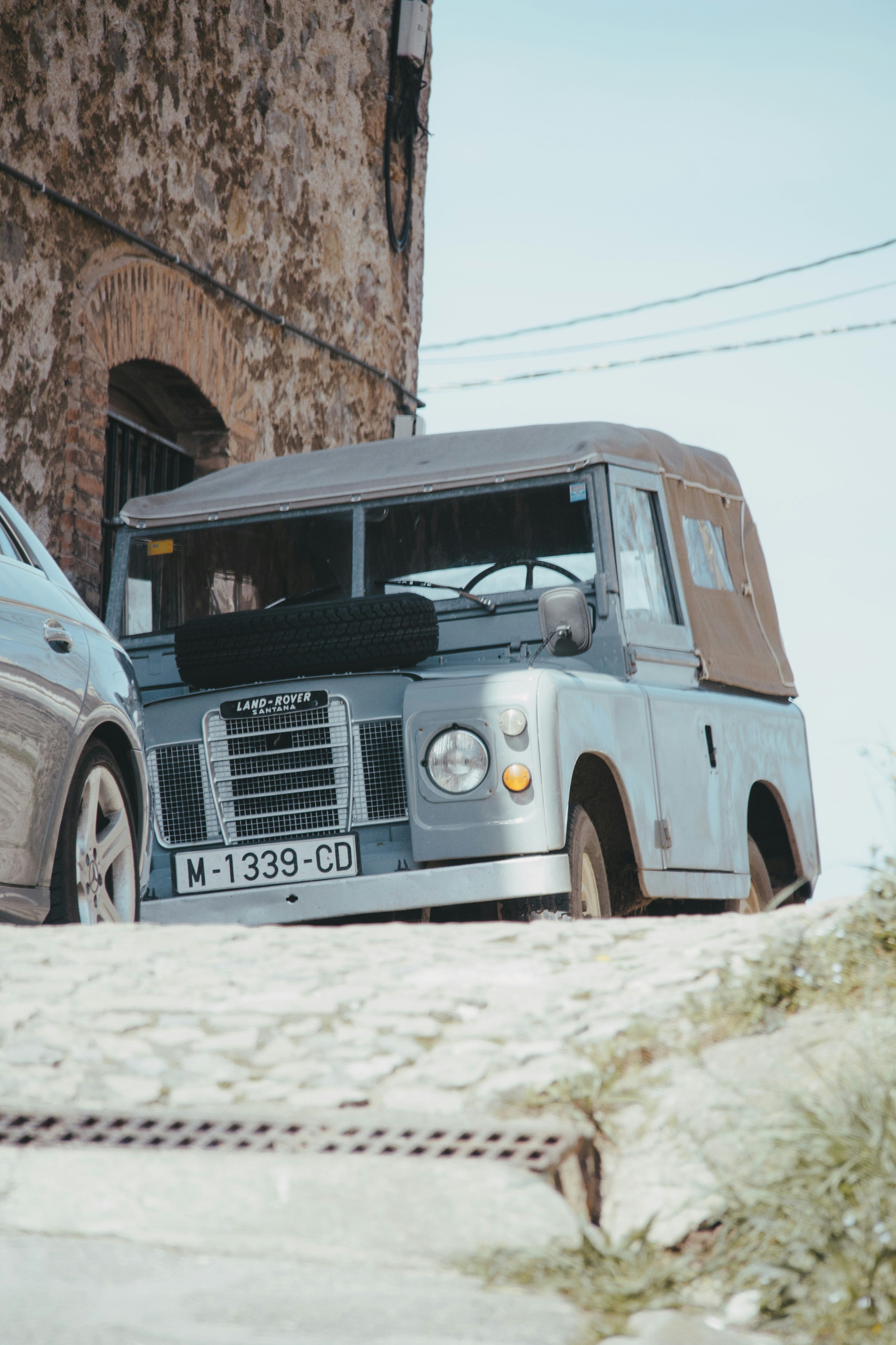 Blue Defender on a Cobblestone Rise beside a Stone Arch